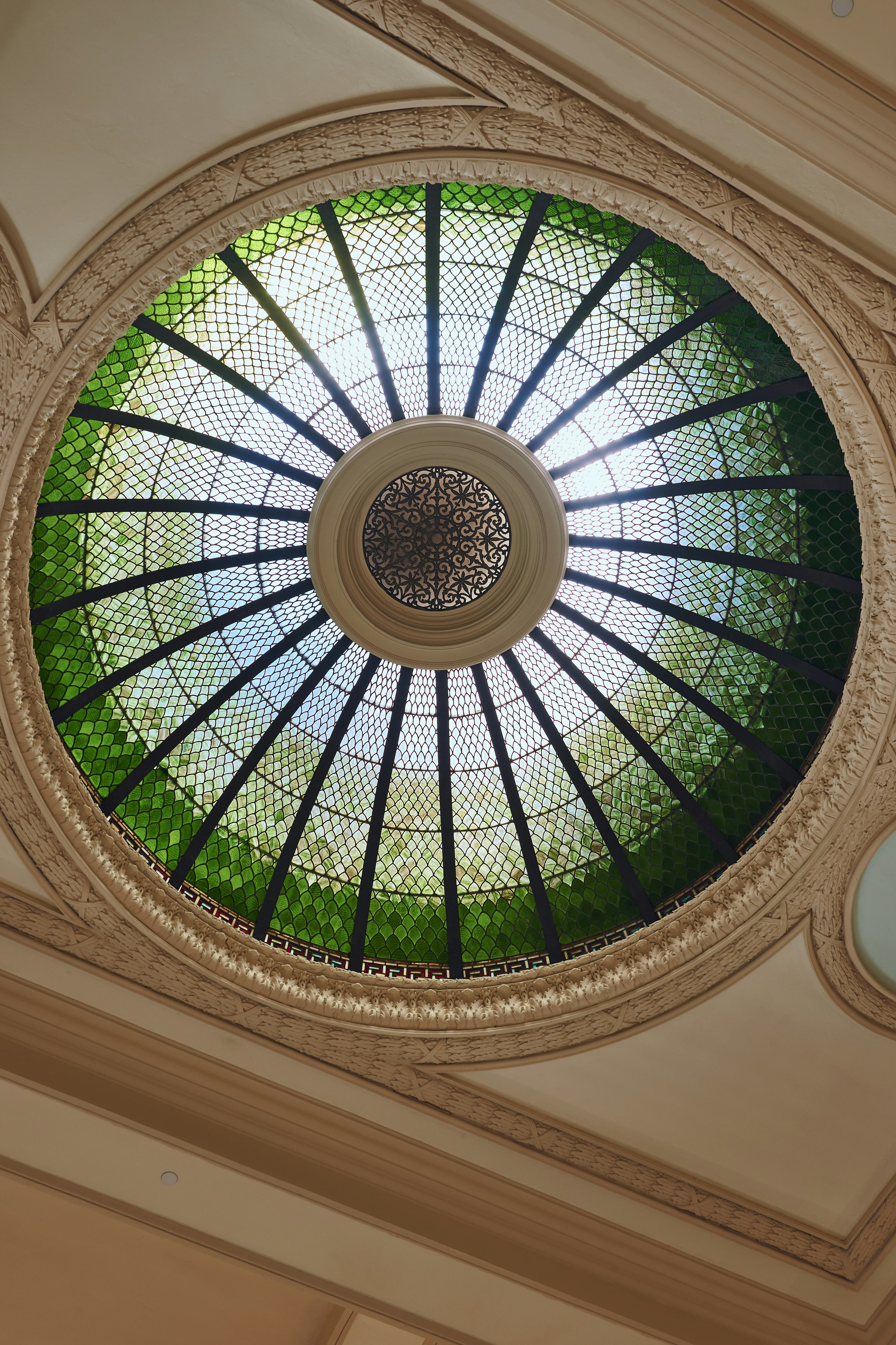 Circular Glass Dome Overhead: Green Radiance with Radial Grille