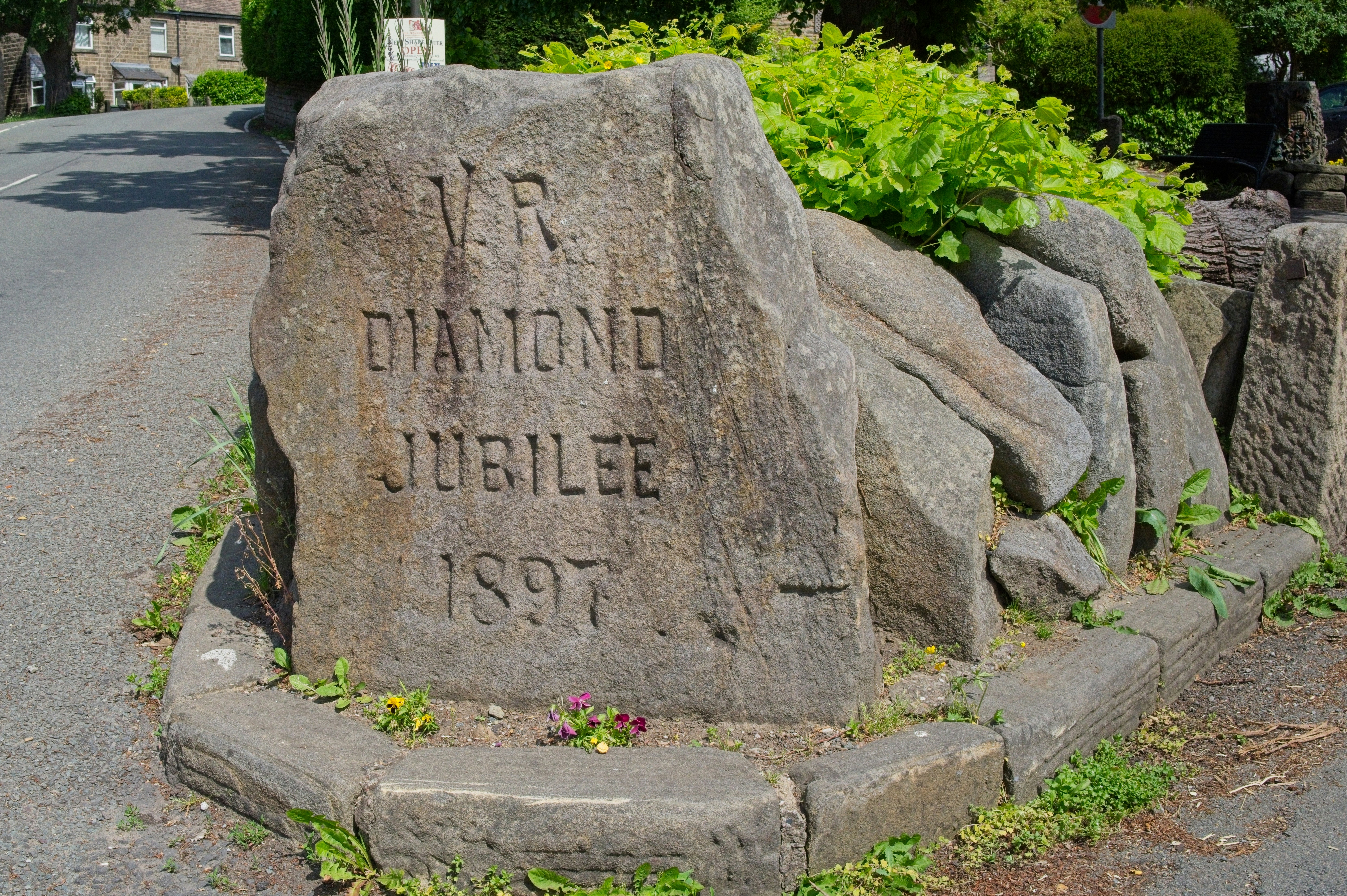 Granite Marker in a Sunlit Village Garden