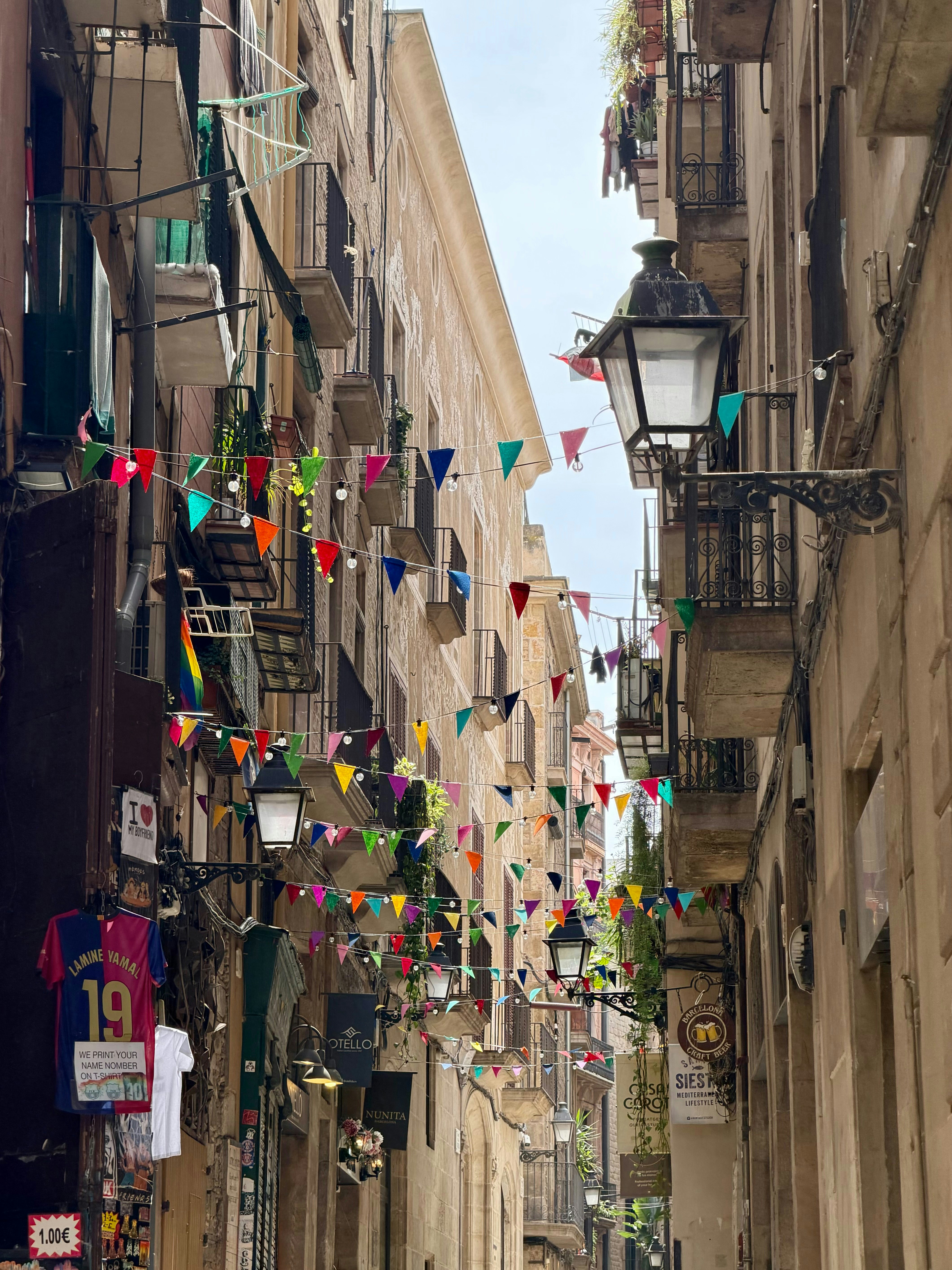 Colorful festival flags in a sunlit old town alley