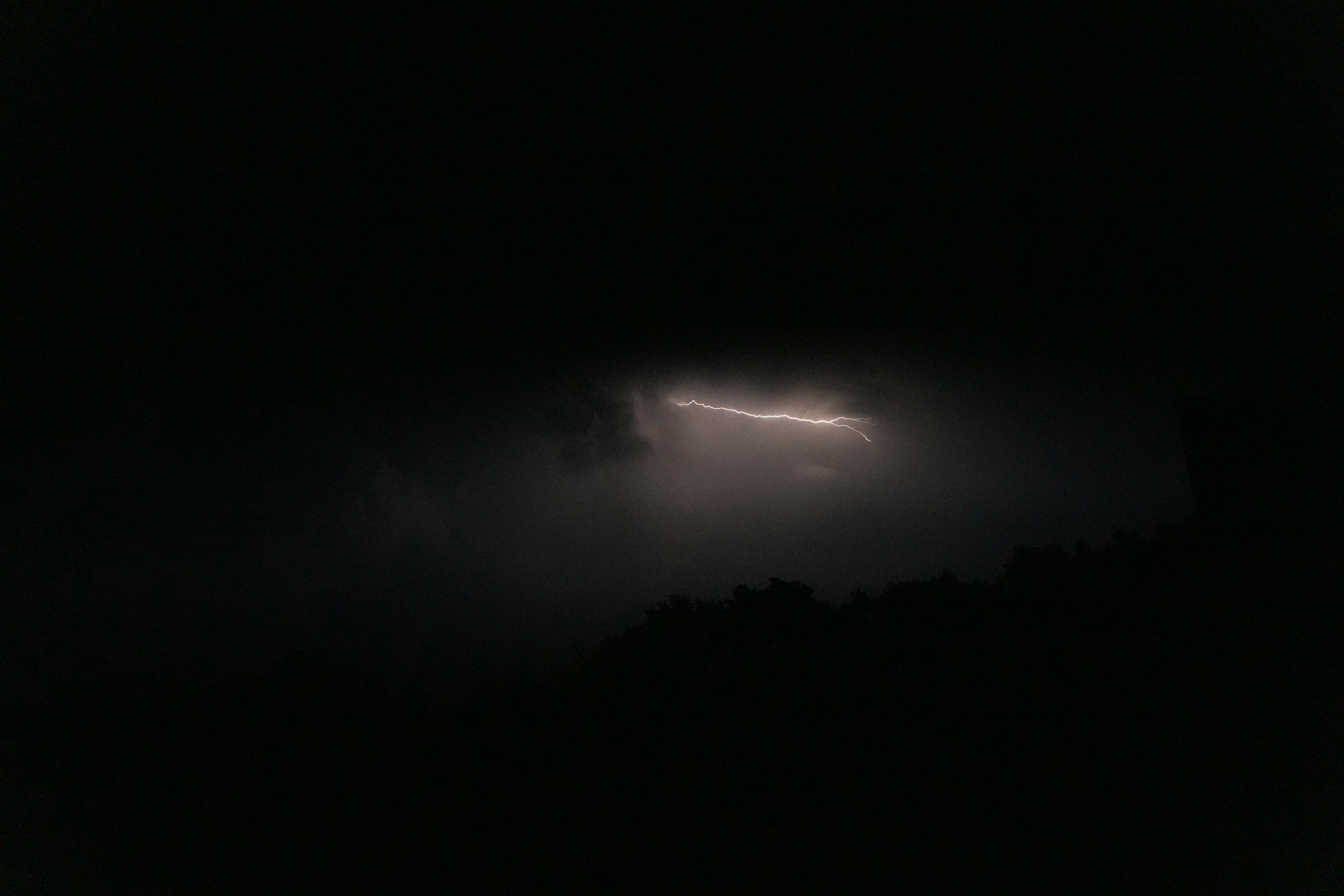 Silent Lumen: A Single Fork of Lightning Rimming the Night
