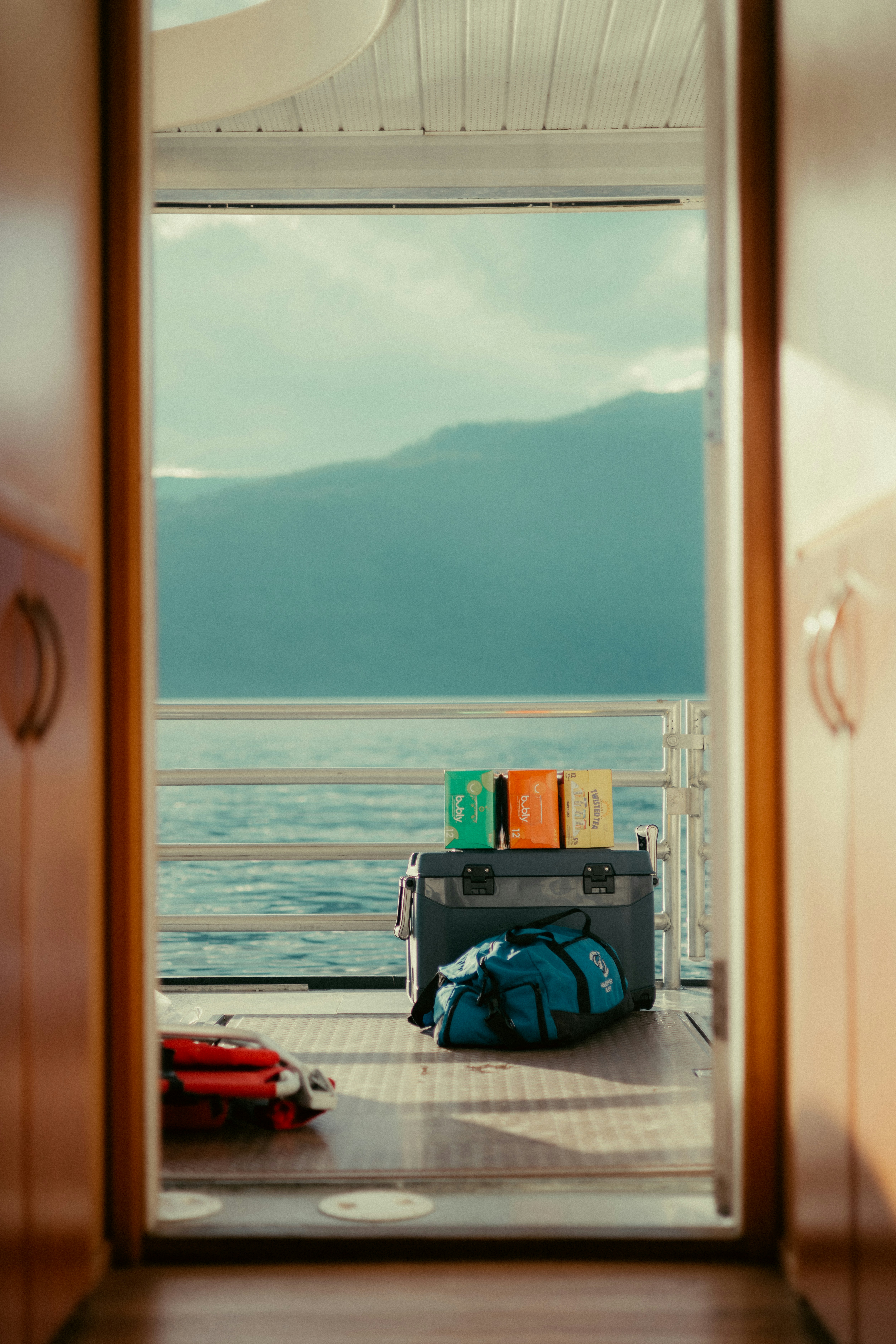 Sea Deck Transition: Equipment and Horizon Framed by Cabin Doors