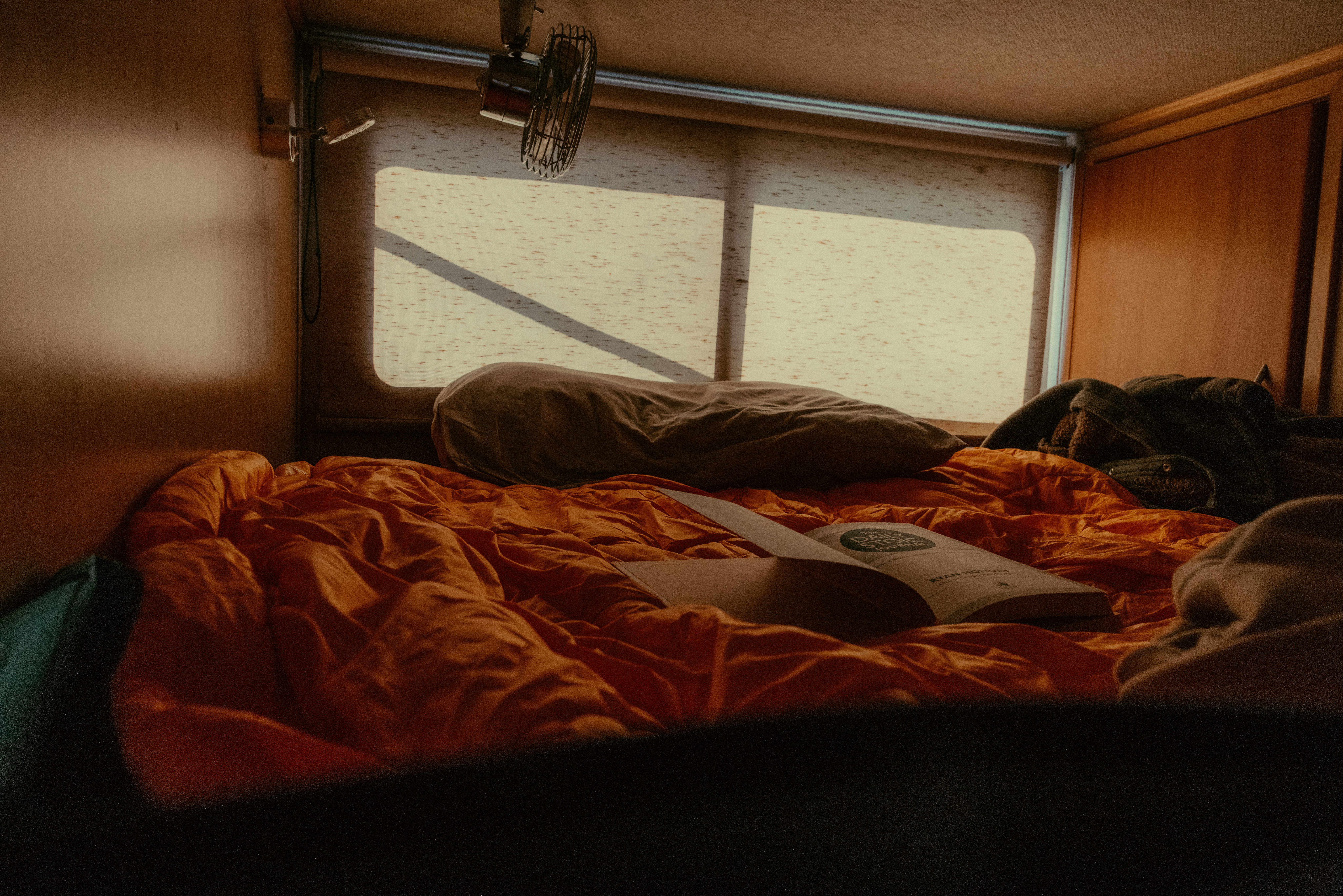 Cozy Camper Bed: The Orange Quilt and Quiet Window