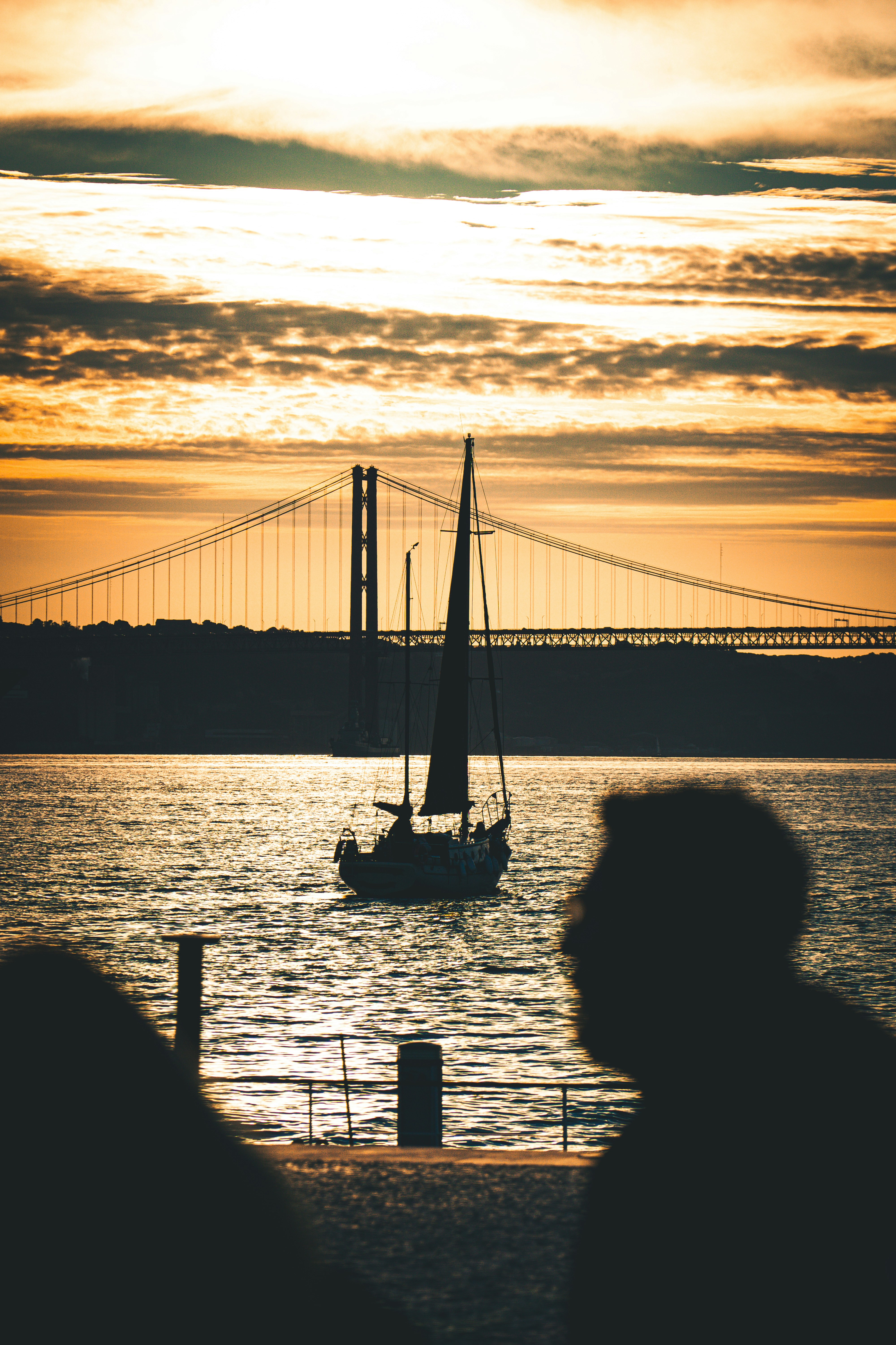 Sailing into Sunset: A Quiet Moment by the Distant Bridge