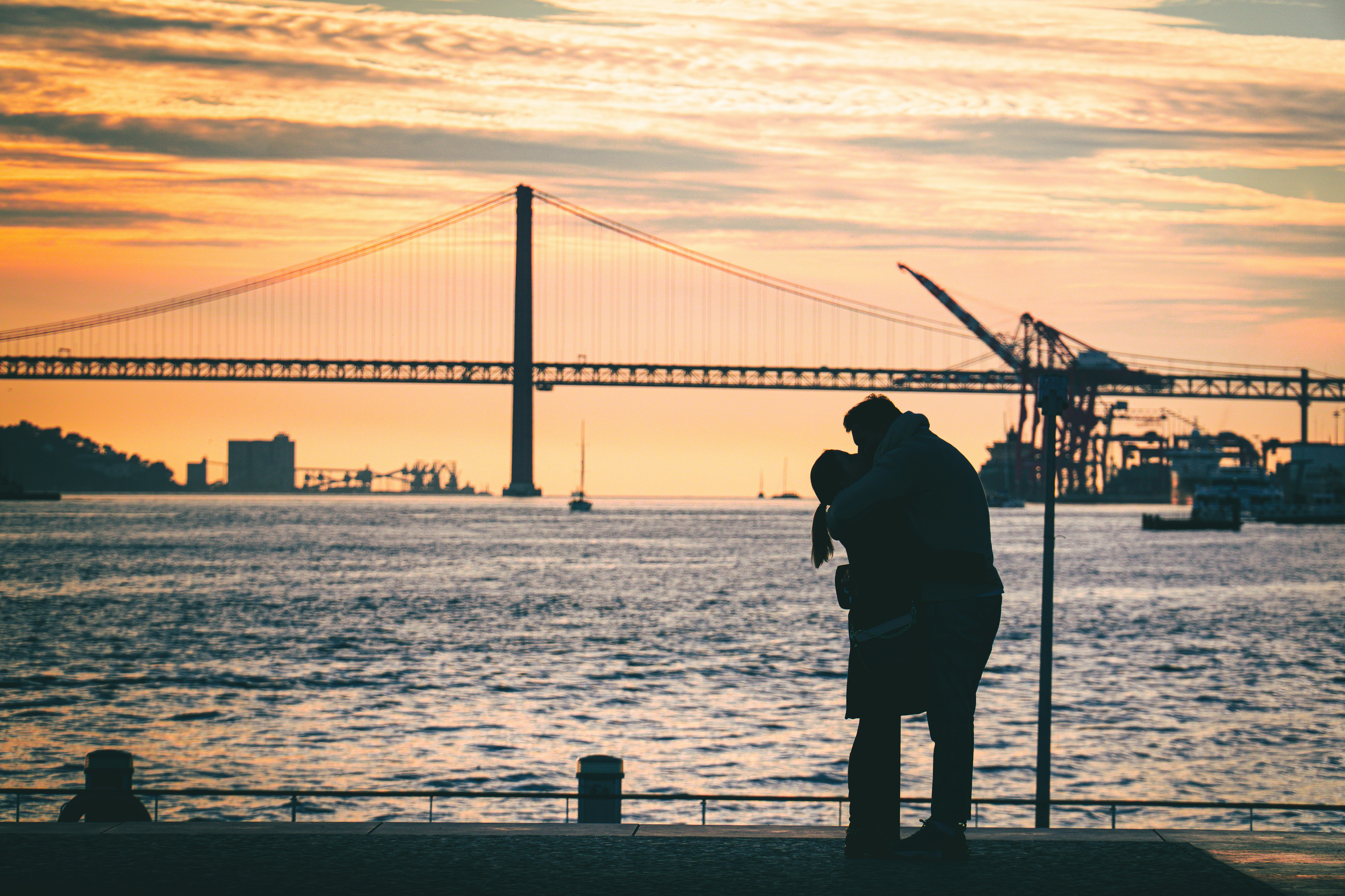Silhouette by the Waterfront: Lovers in the Golden Hour