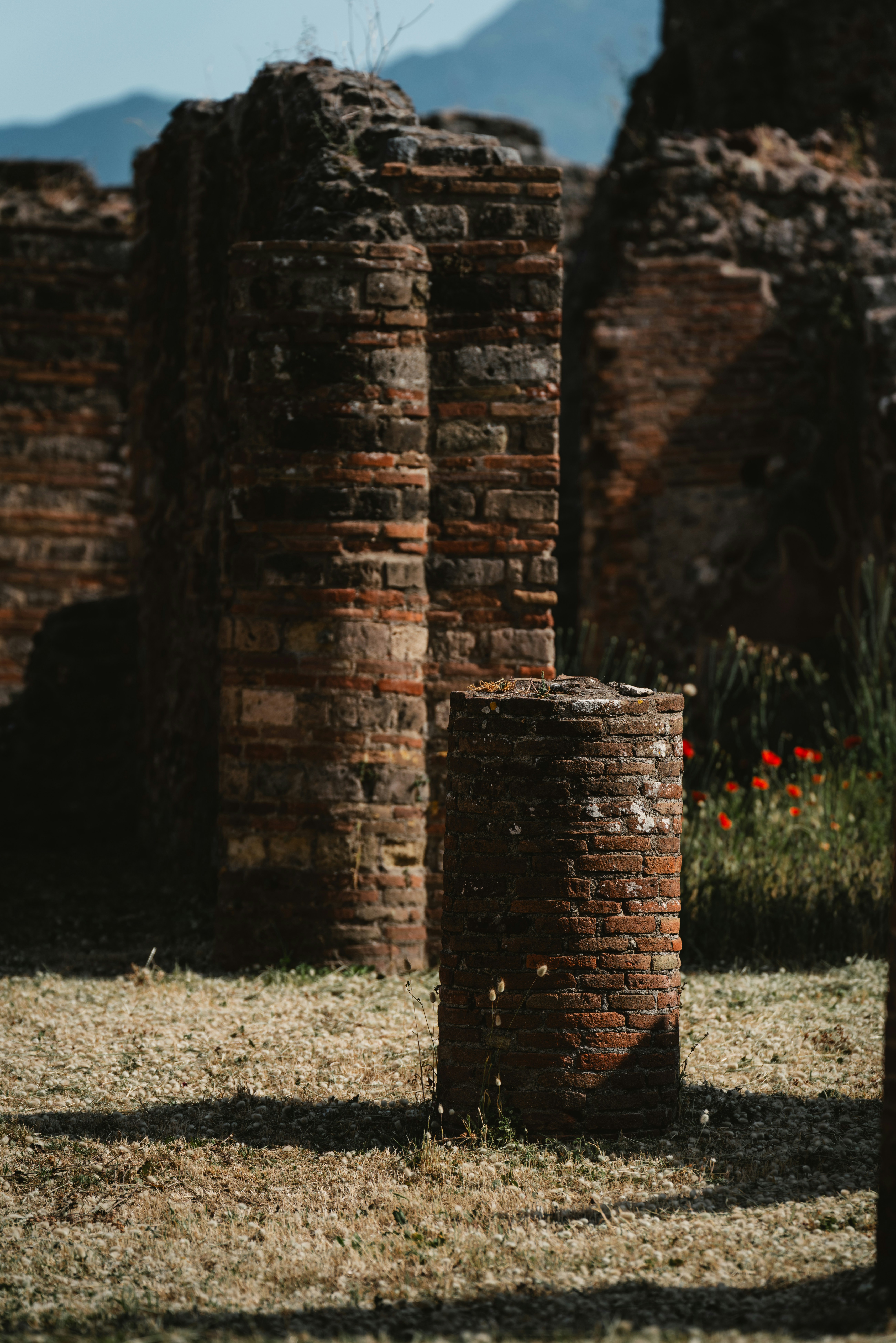 Ancient Red Brick Pillars in Dappled Sunlight