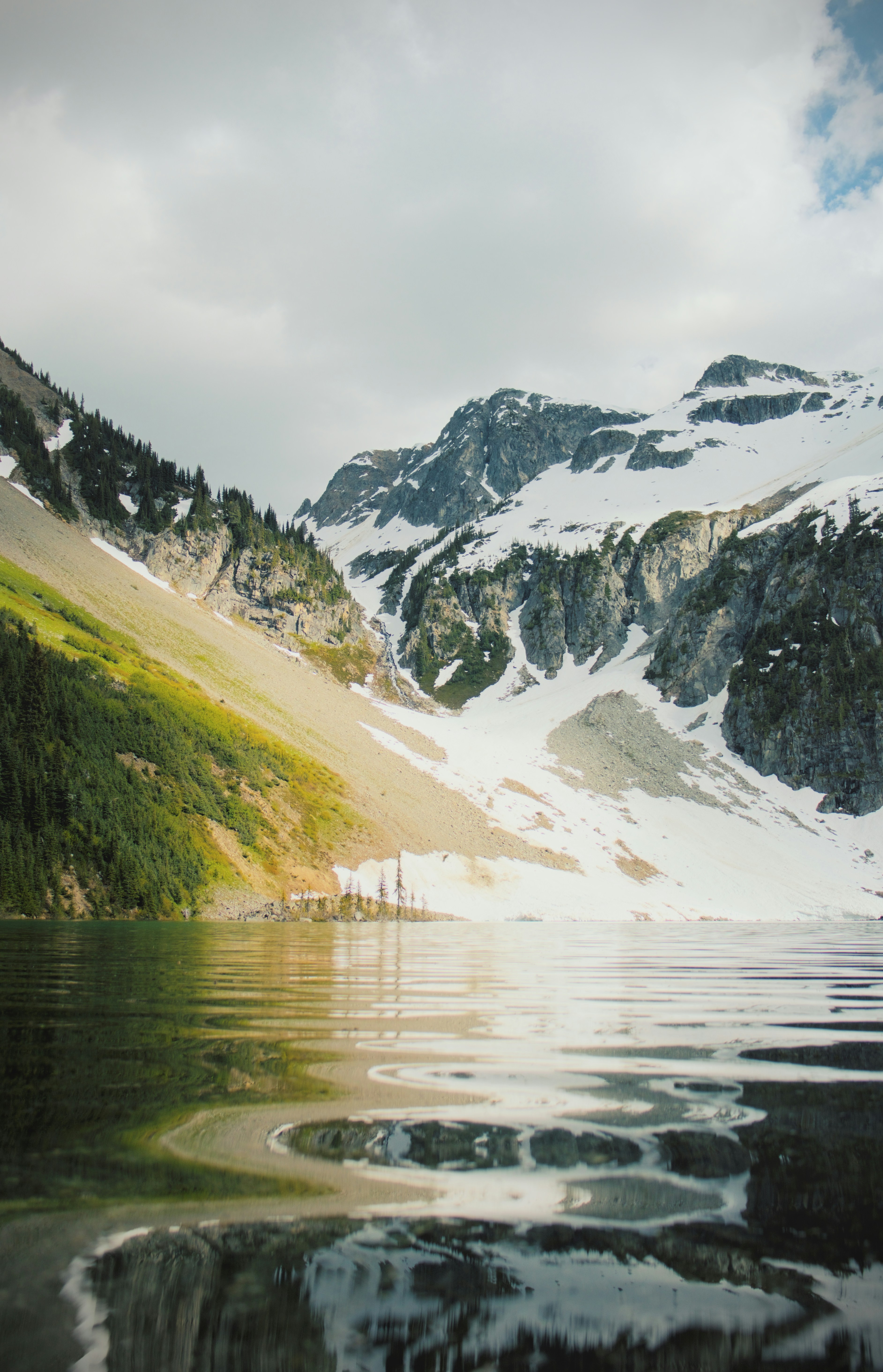 Snowbound Ridge Reflections Across Glacier Lake