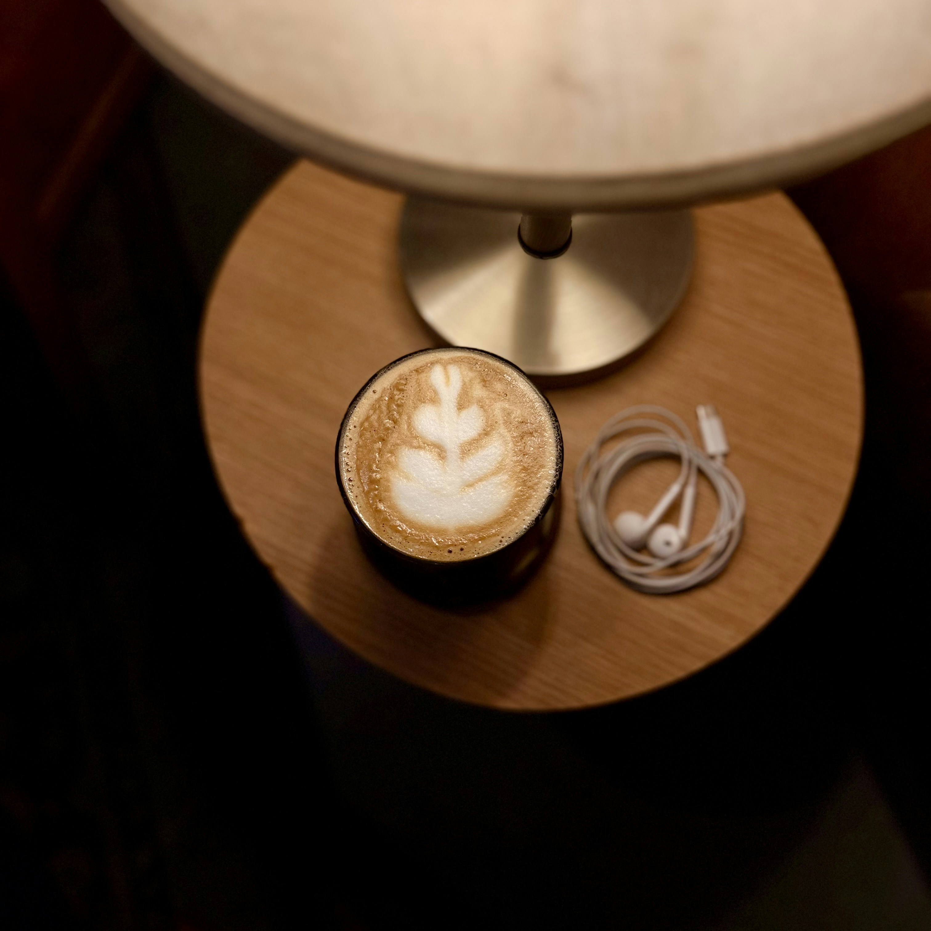 A Quiet Latte Moment Under Soft Lamp Light