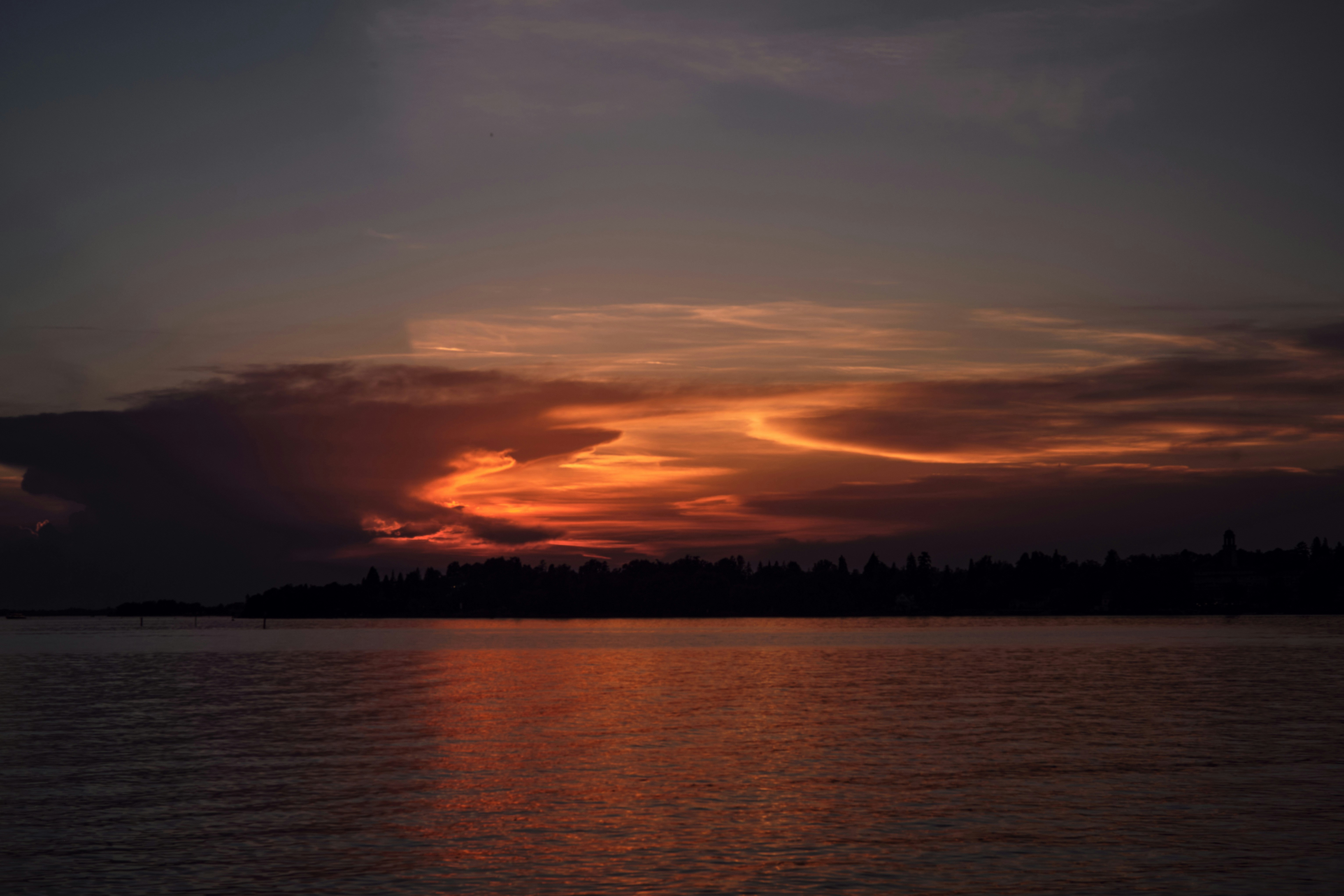 Crimson Horizon: Sunset Over a Serene Lagoon