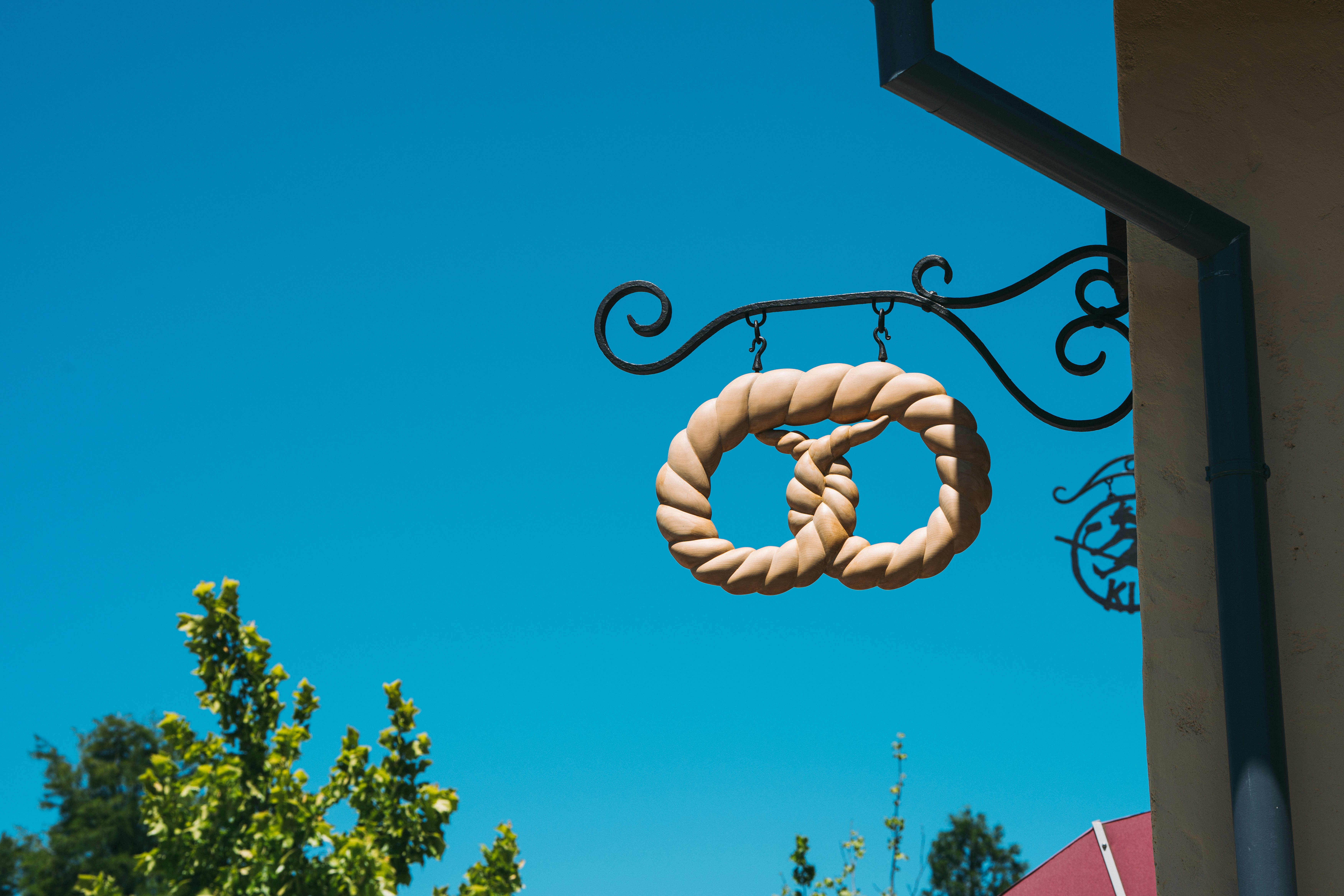 Rope World: A Hanging Sign Against a Clear Blue Sky