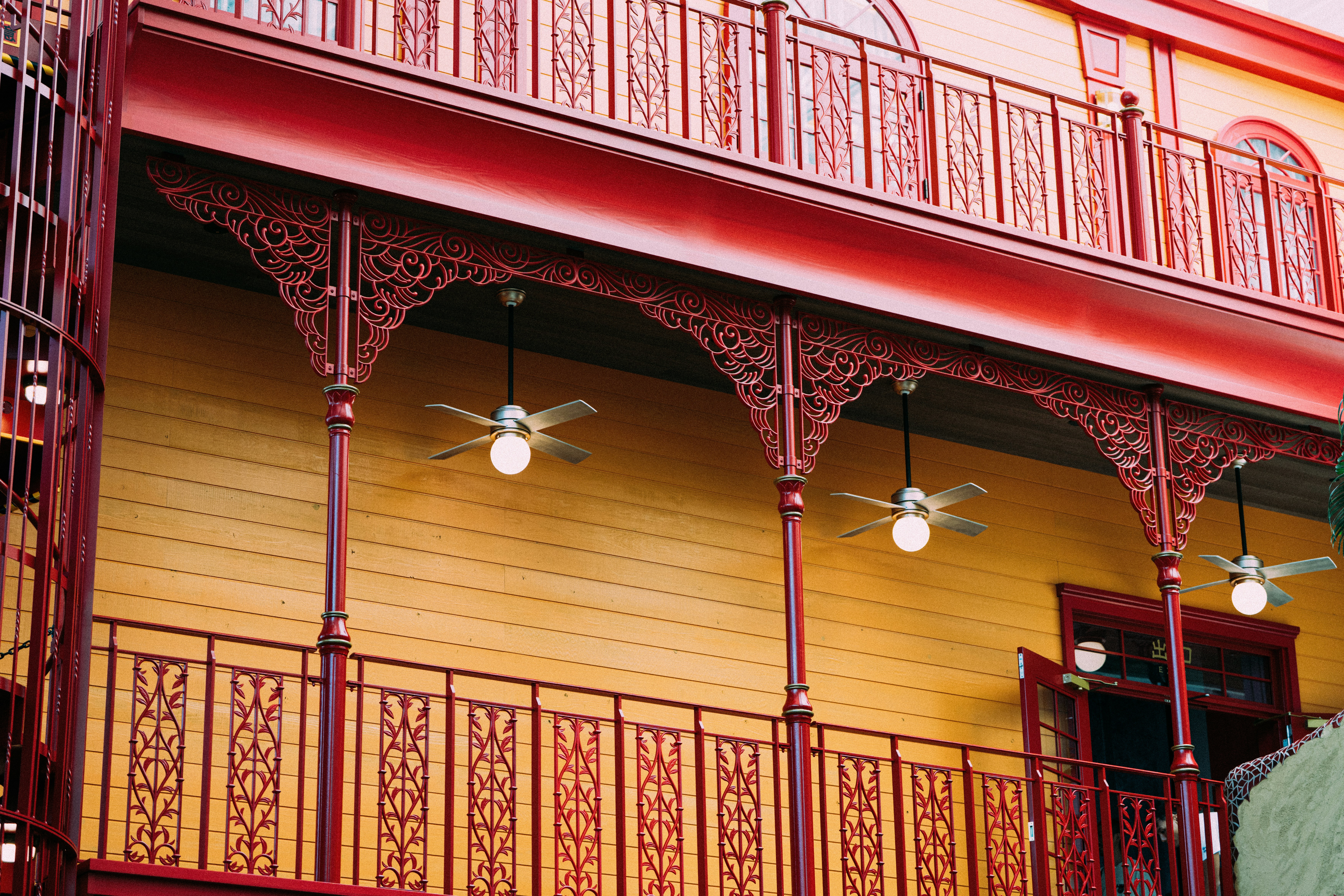 Red Balcony Elegance: A Colonial Facade with Ornate Ironwork