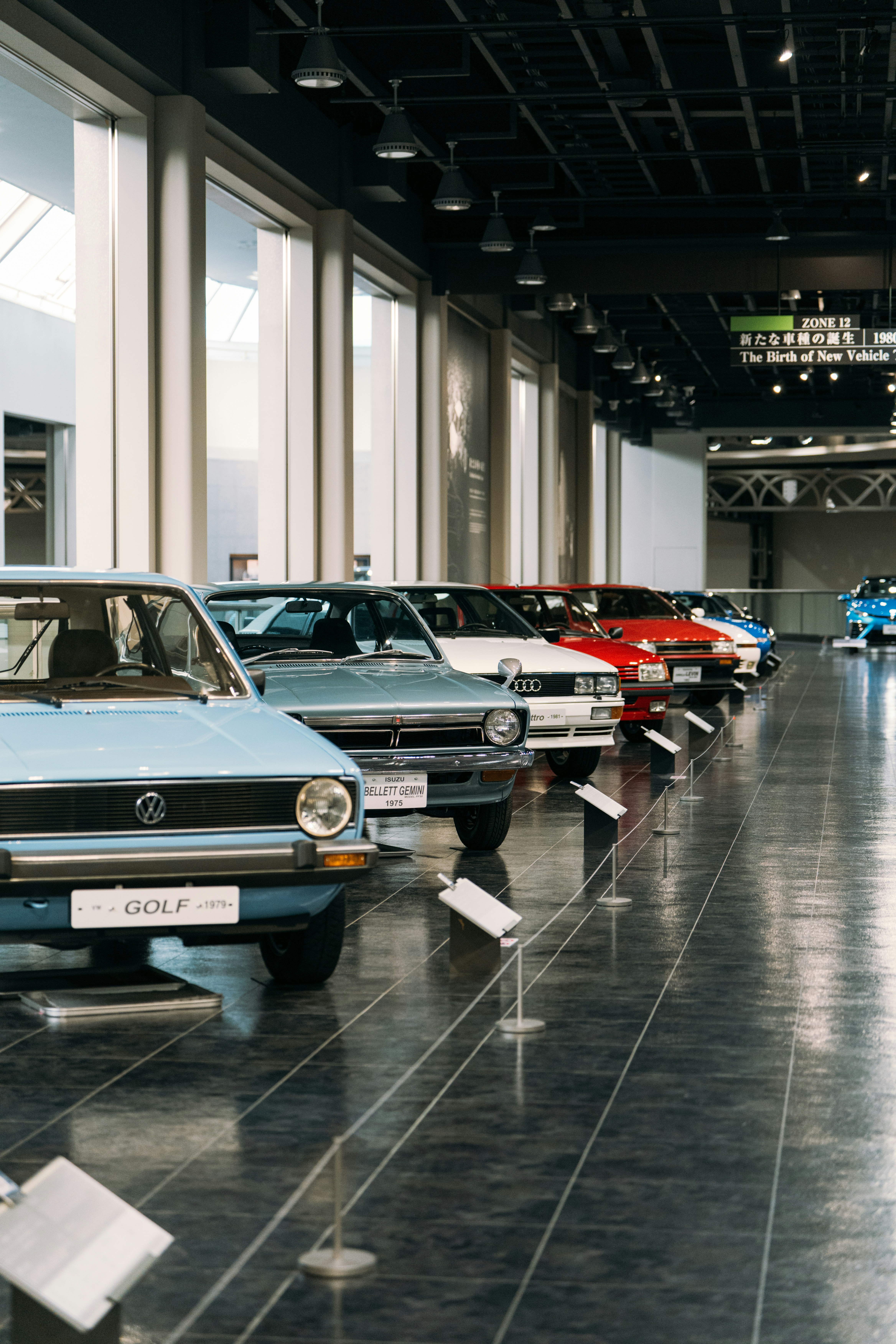 Line of Classics: A Row of Vintage Cars in a Modern Exhibition Hall