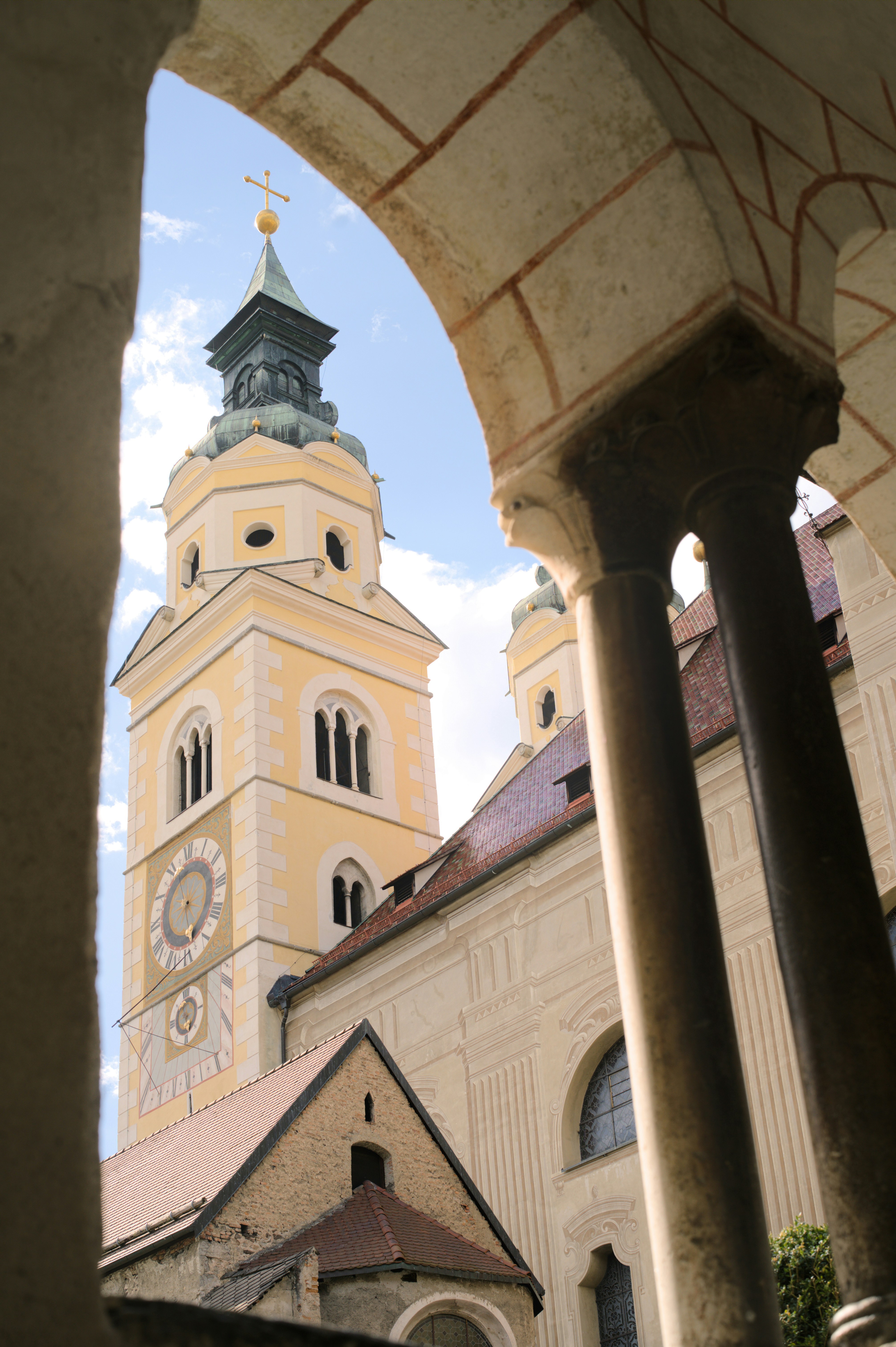 Clerestory of Time: A Yellow Clocktower Framed by Curved Arches