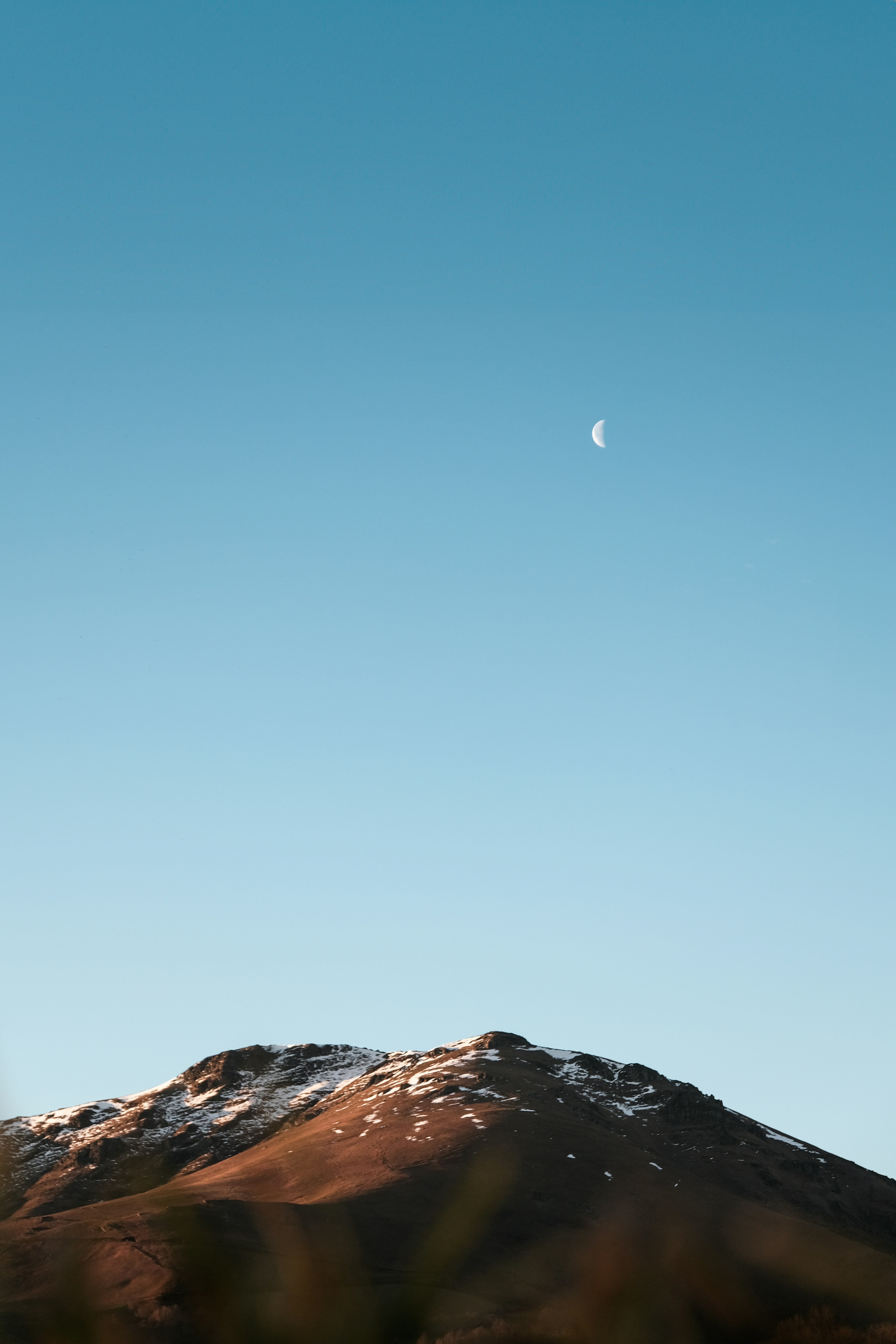 Moonlit Ridge at Dusk Over a Snow-dusted Tor