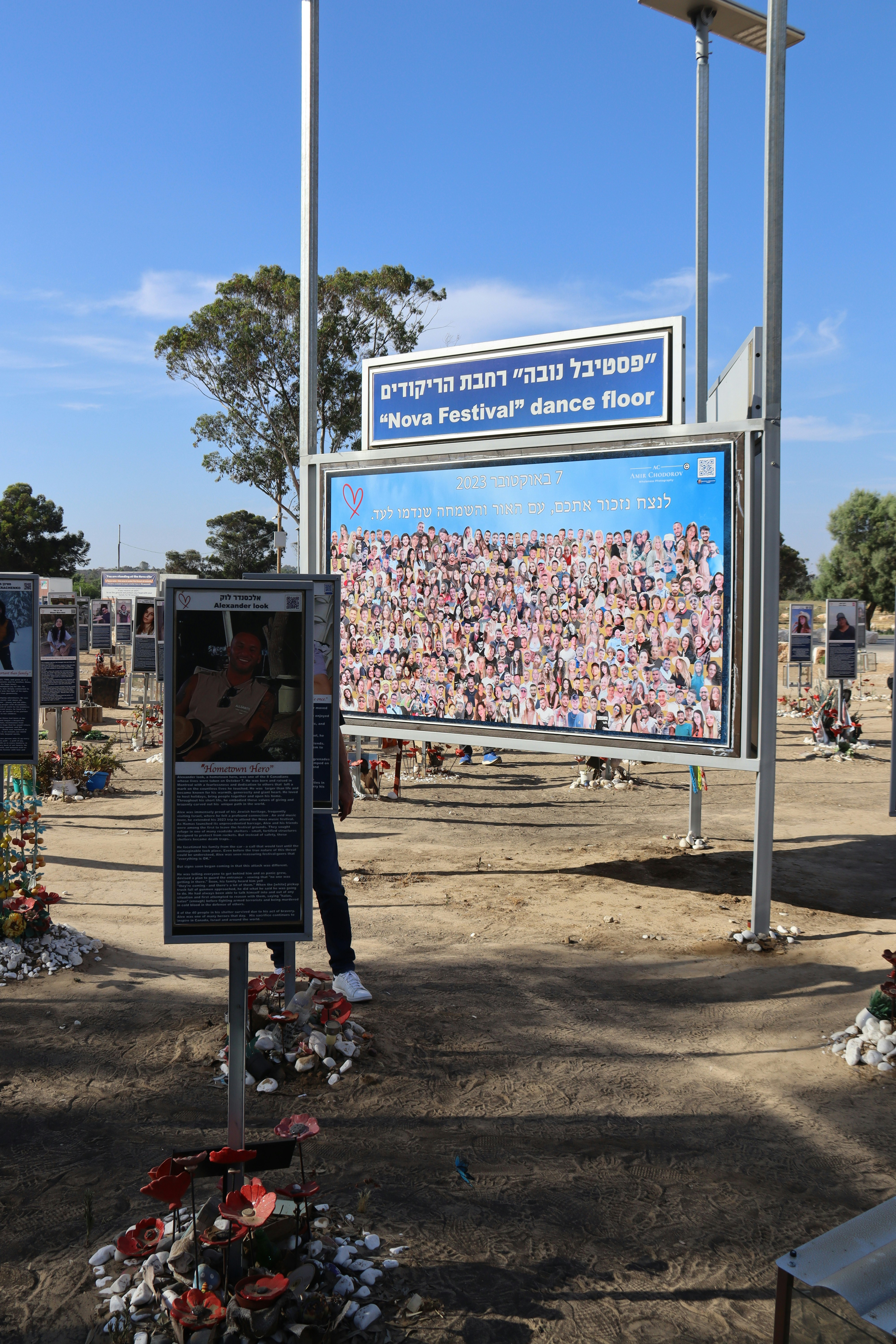 Exhibit of Unity: A Wall of Portraits Framed by Blue Festival Signage
