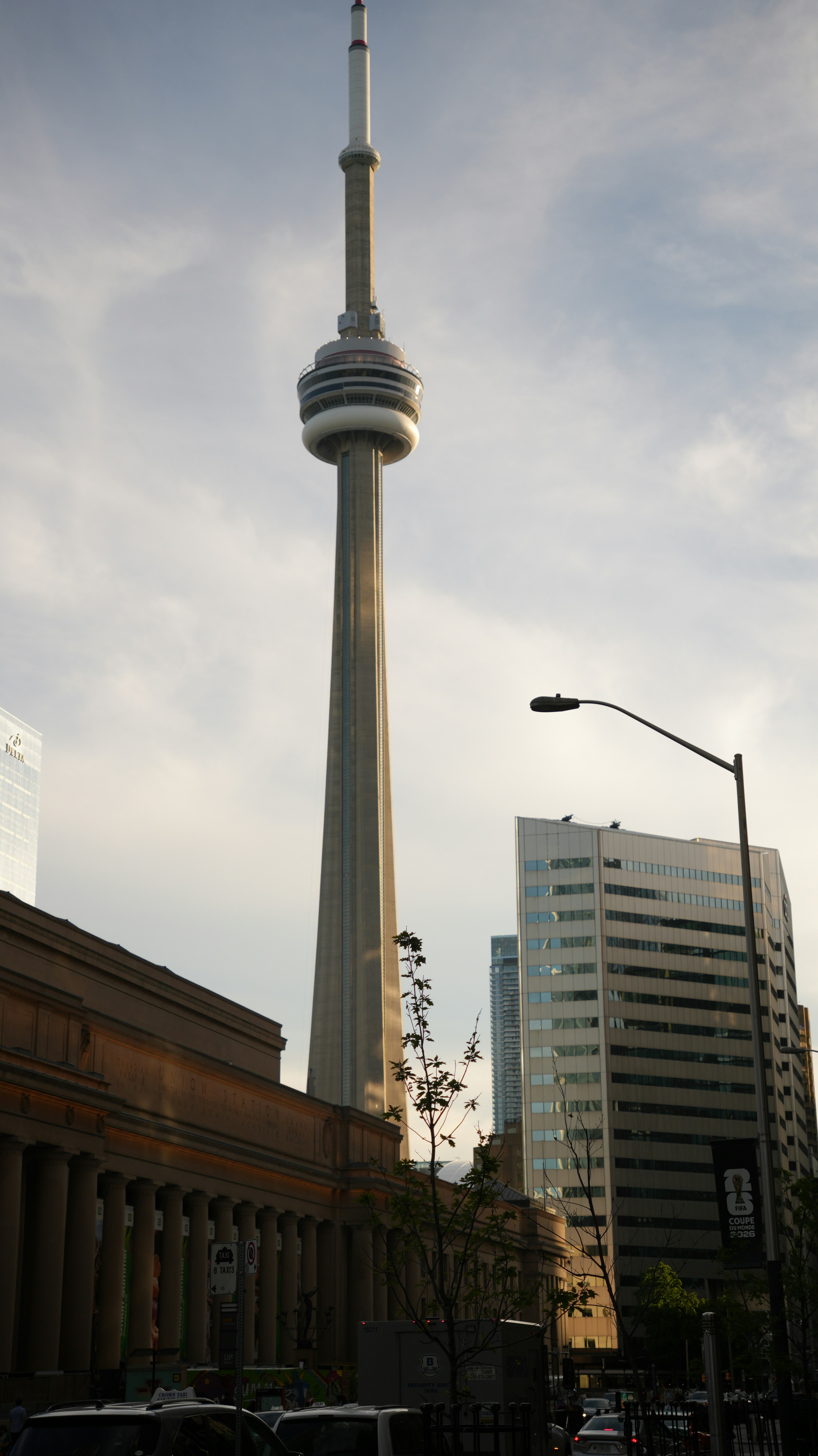 Toronto's Needle: City Tower Rising Above Classical Arcades
