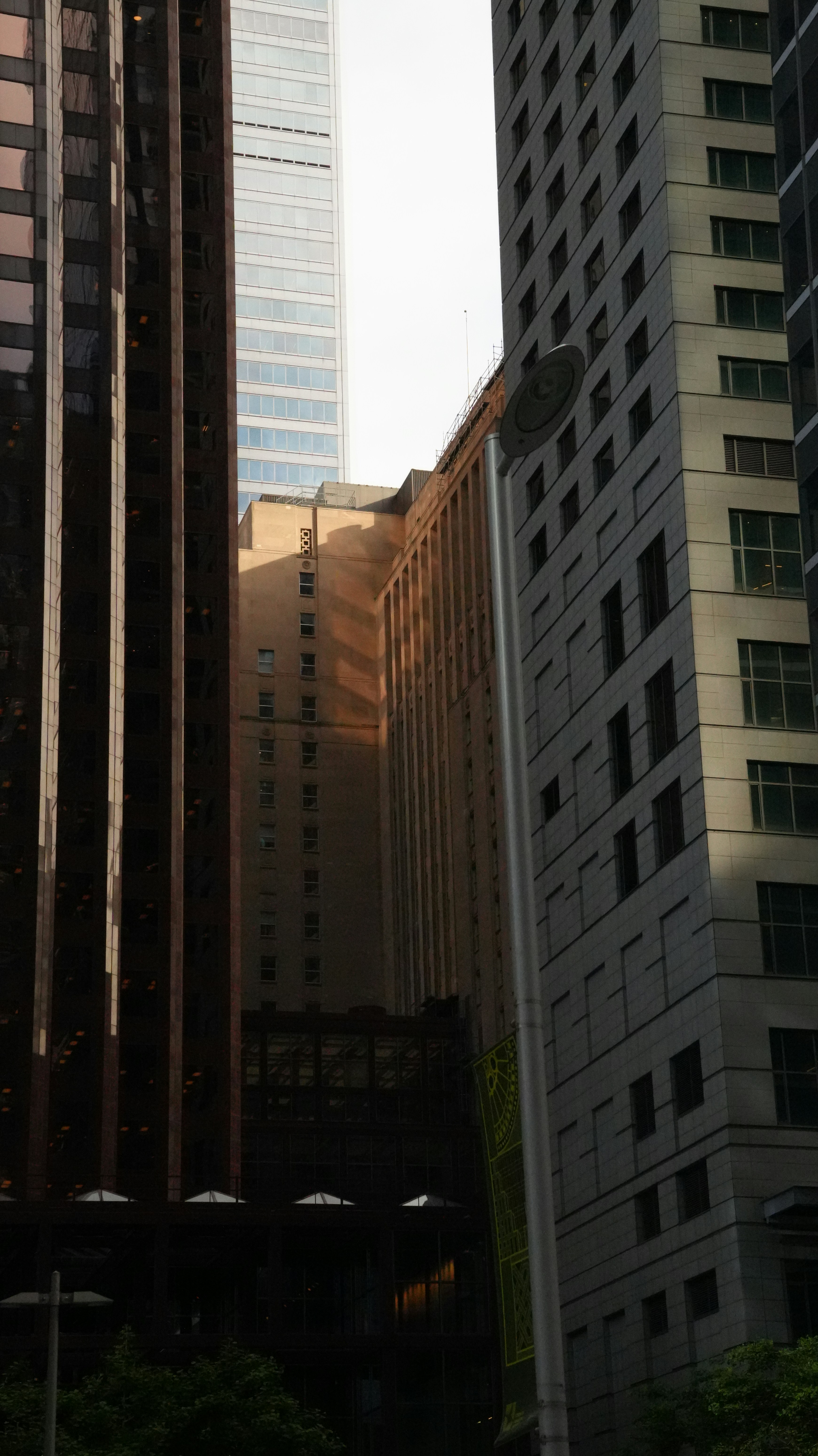 Vertical City Corridor: Narrow Gap Between Skyscrapers at Sundown