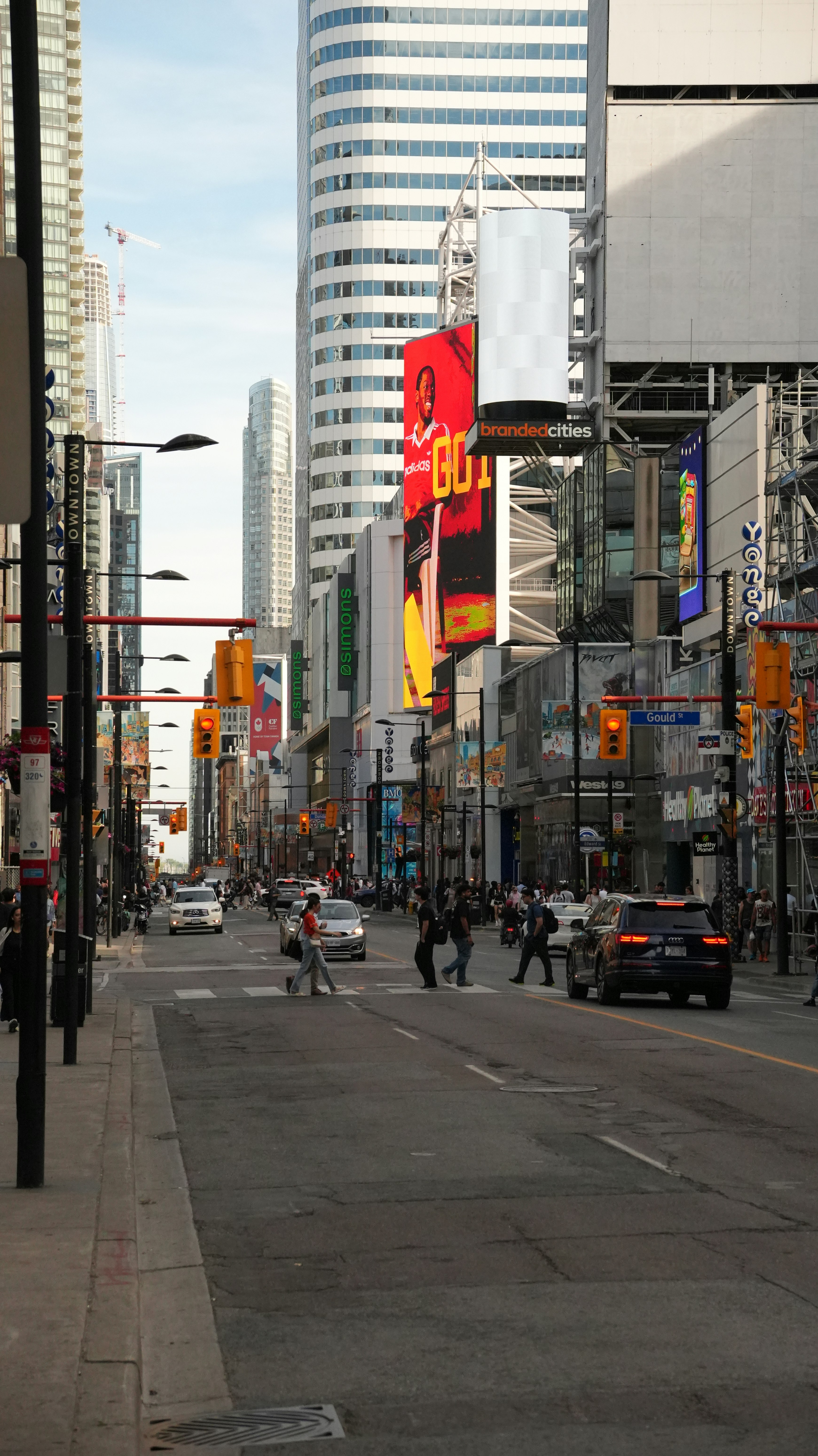 City Pulse at Dusk: Neon Screens and Street Crossing