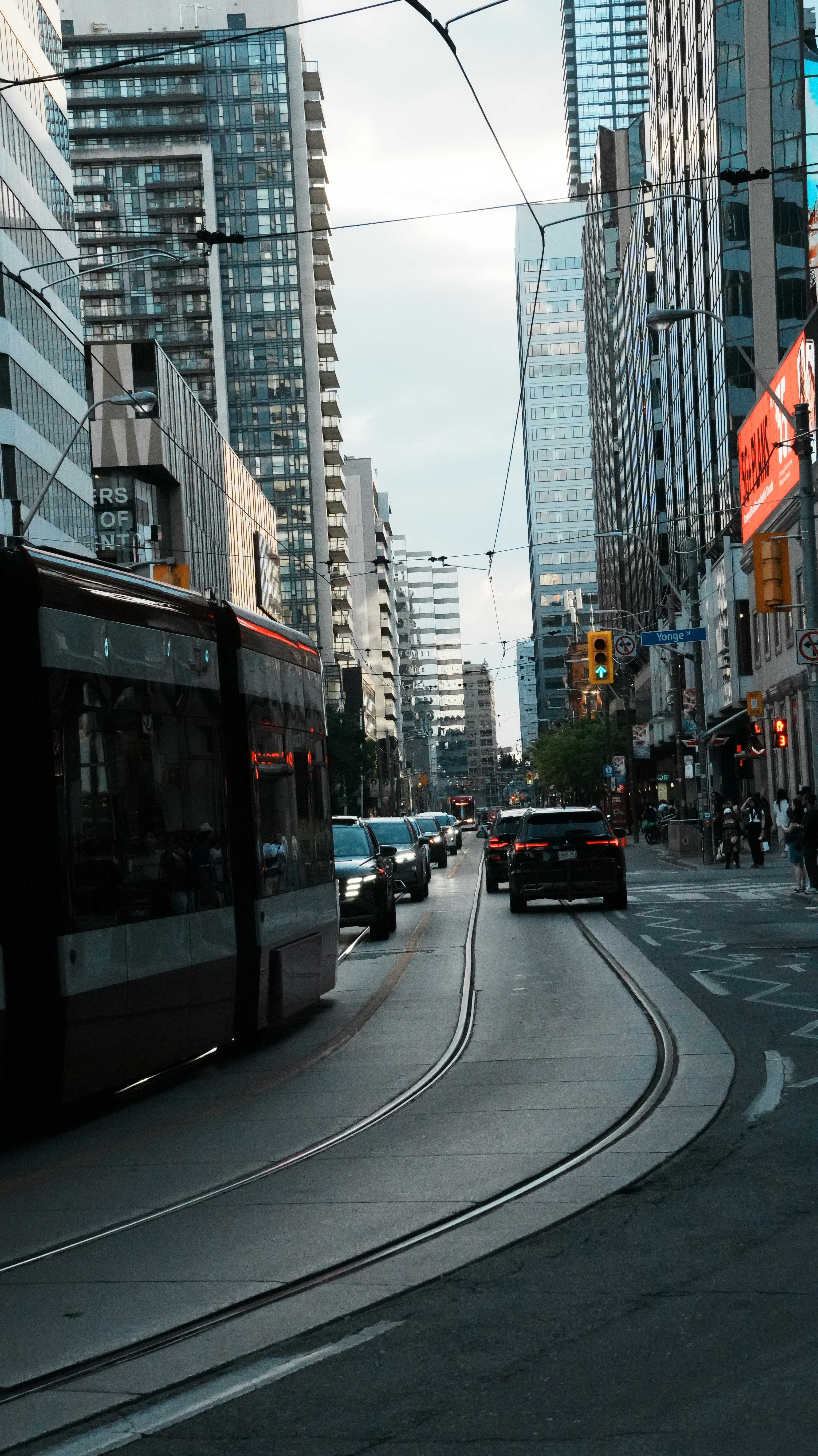 A Toronto streetcar traveling through downtown during a summer evening.
