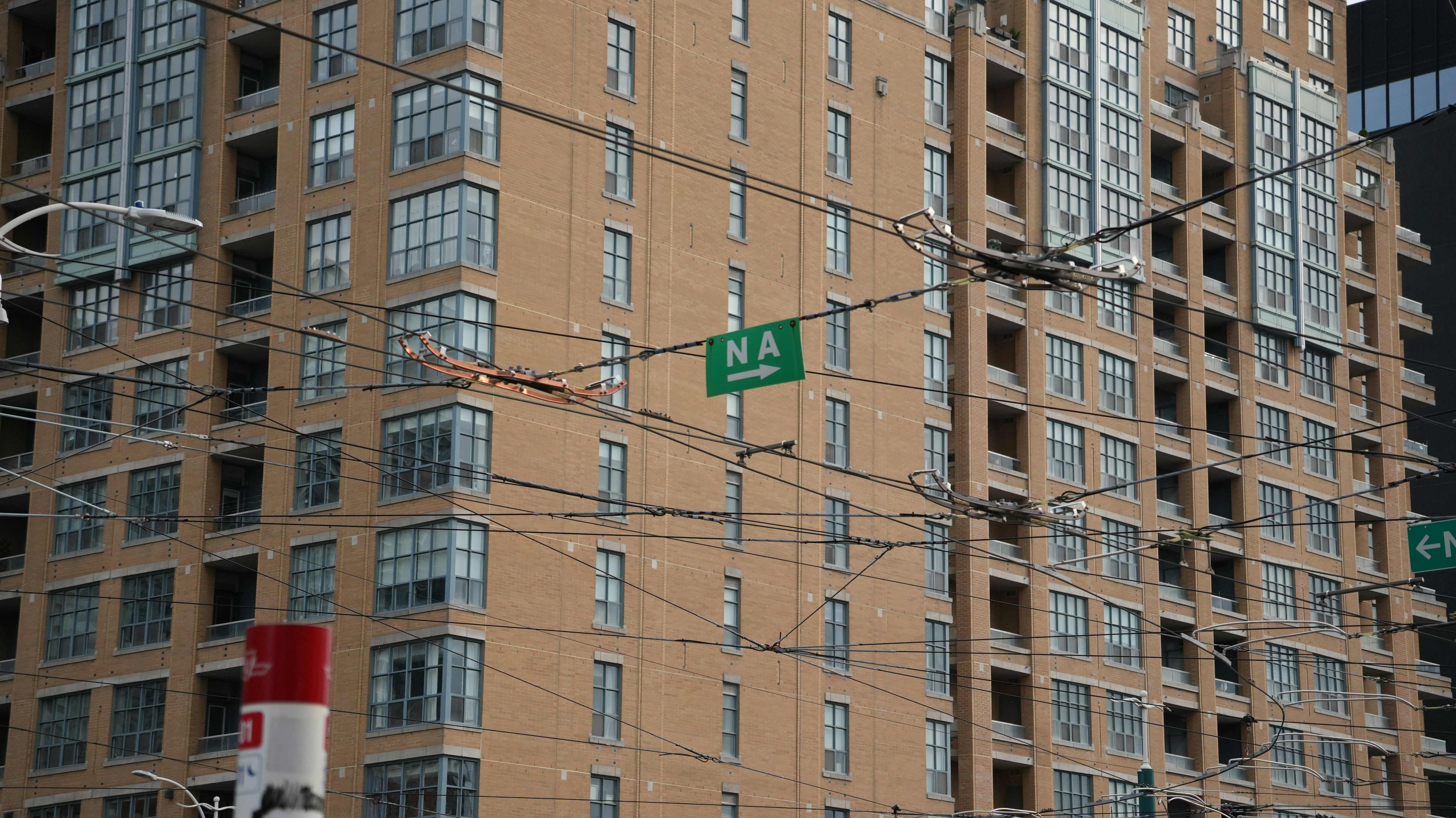 Urban Facade Avenues: Glass, Brick, and Transit Wires