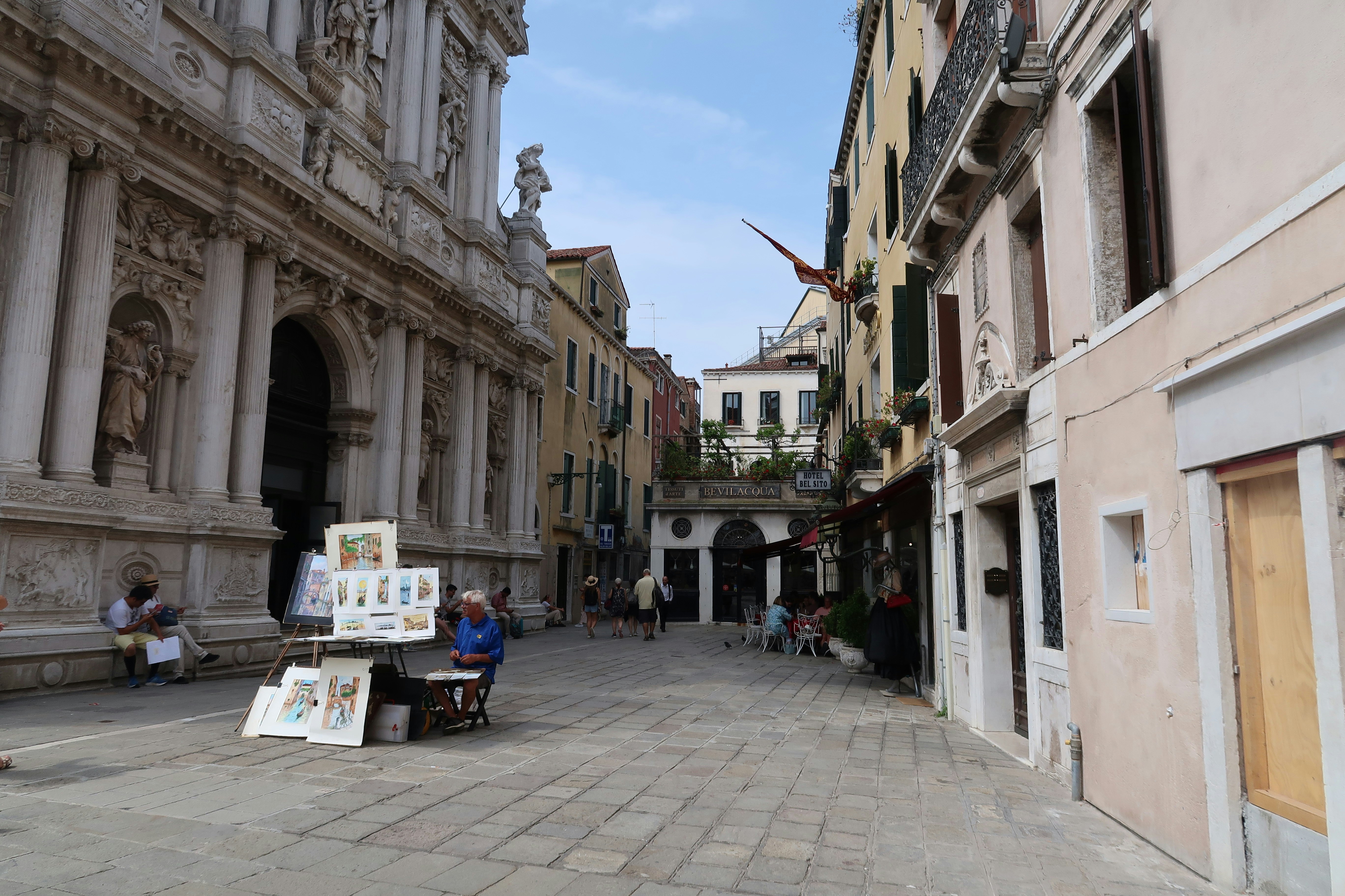 Cobbled Street Portrait: Facades, Flags, and Faraway Arches
