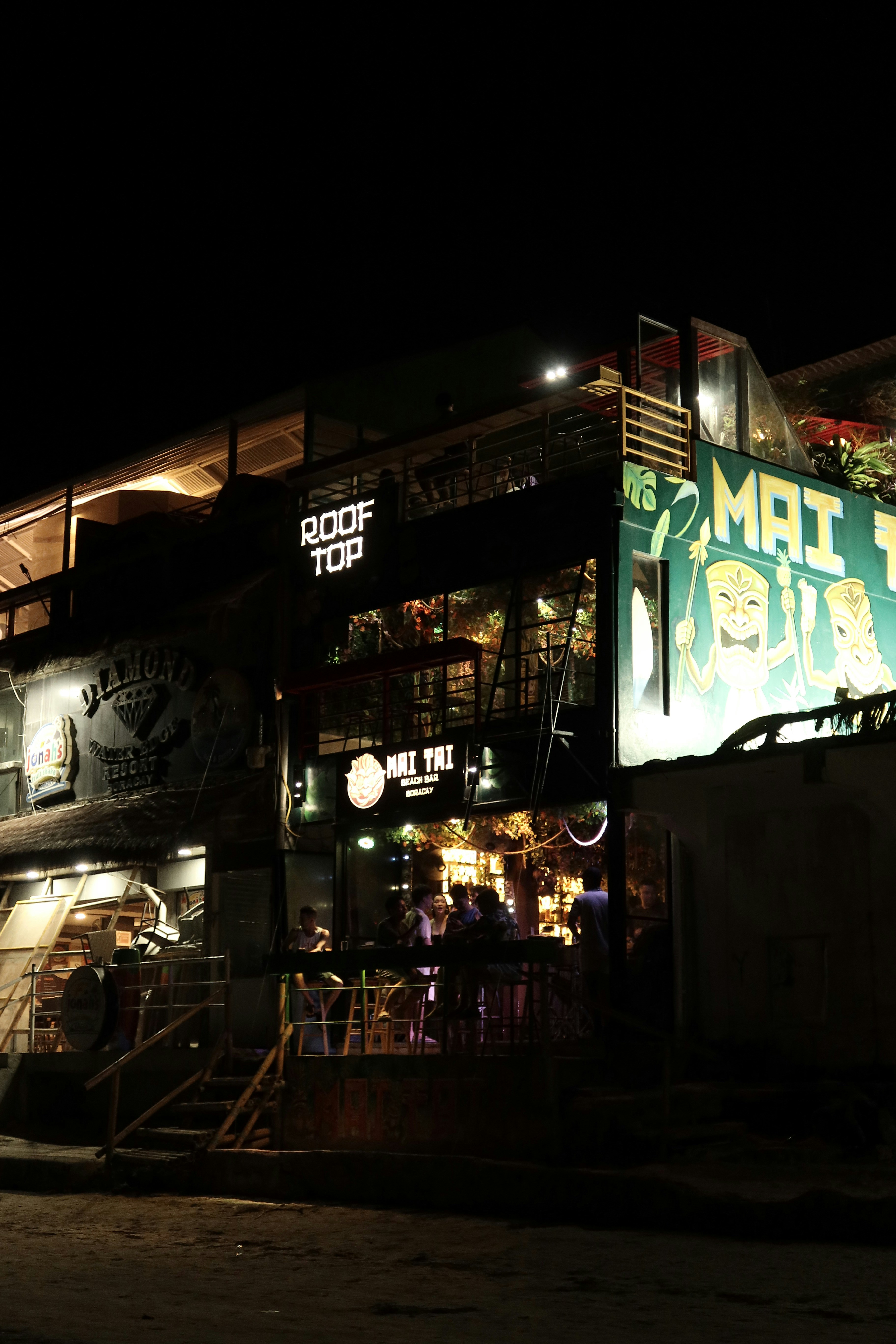 Nightlife at the Riverside Lounge: Neon Signage and Painted Facade