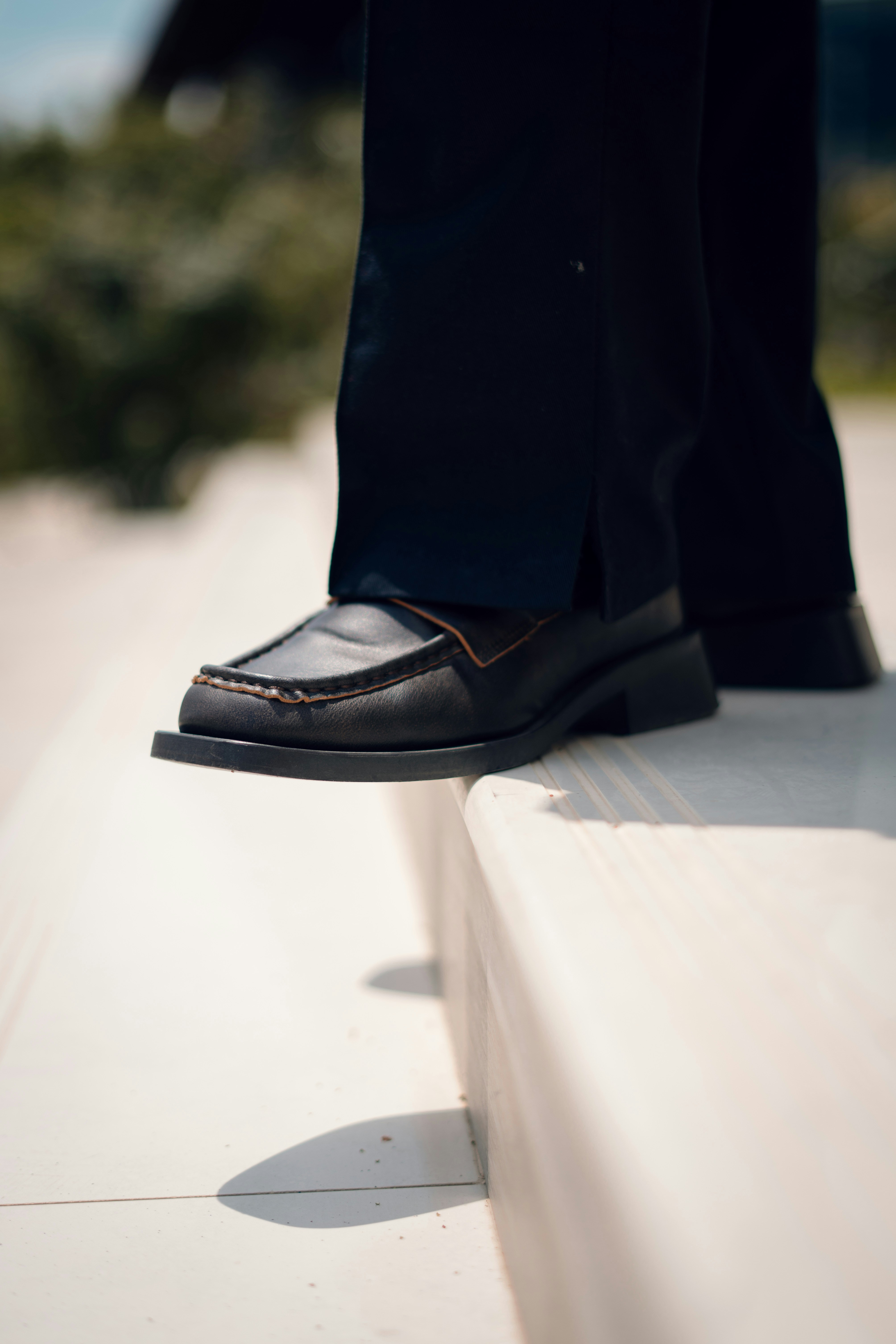 A Step Above: Close-Up of Polished Leather on a Simpler Edge