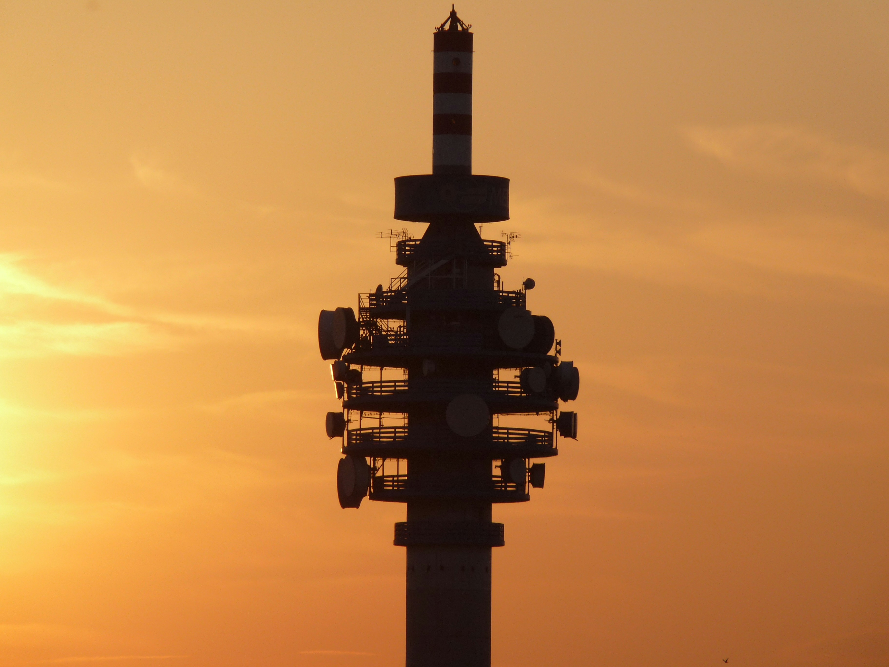 Silhouette of a communications tower at golden hour