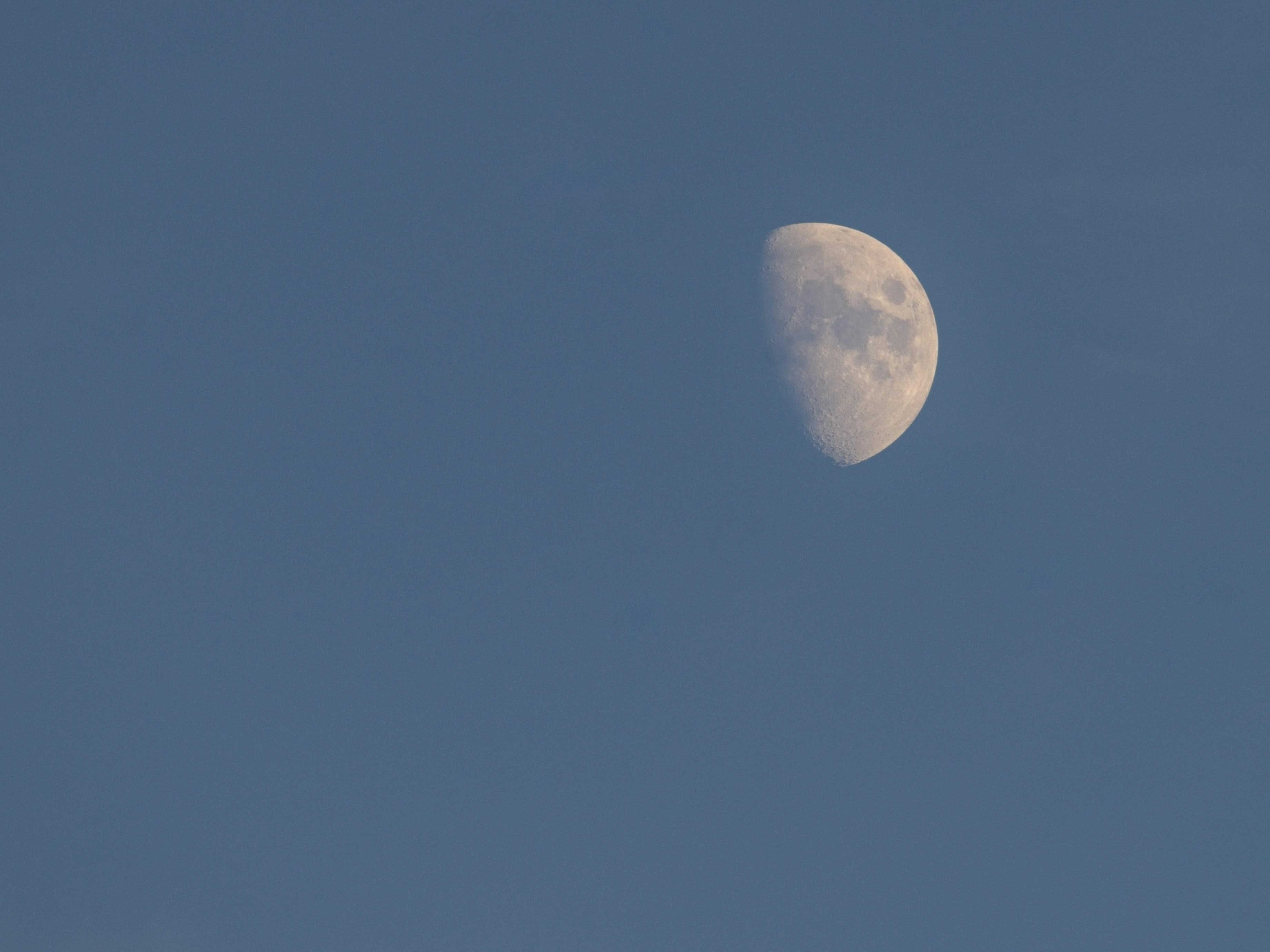 Lone Moon Crescent Beyond a Clear Evening Sky