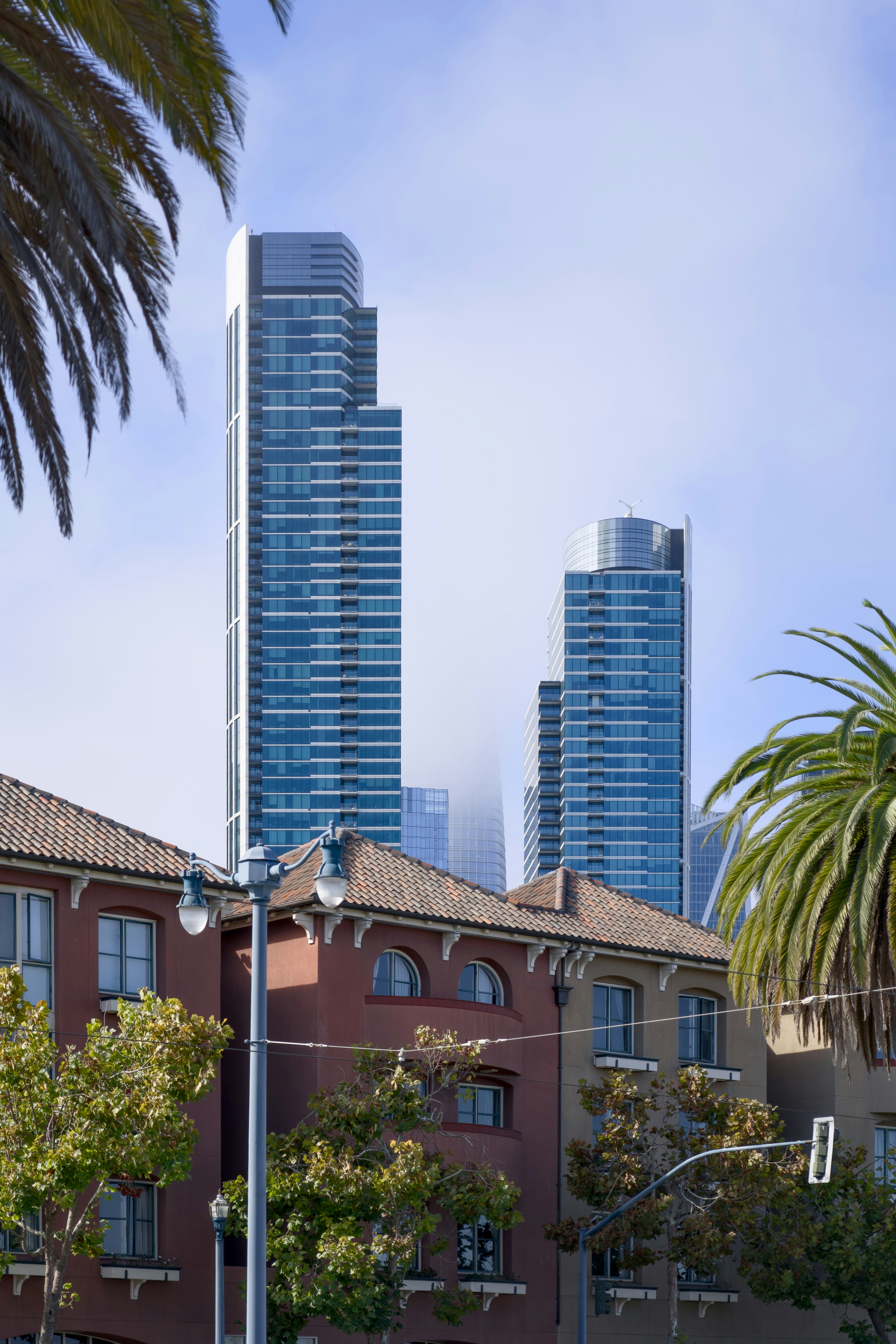 Midtown Echoes: Skyscrapers Rise Behind Red-Tile Row