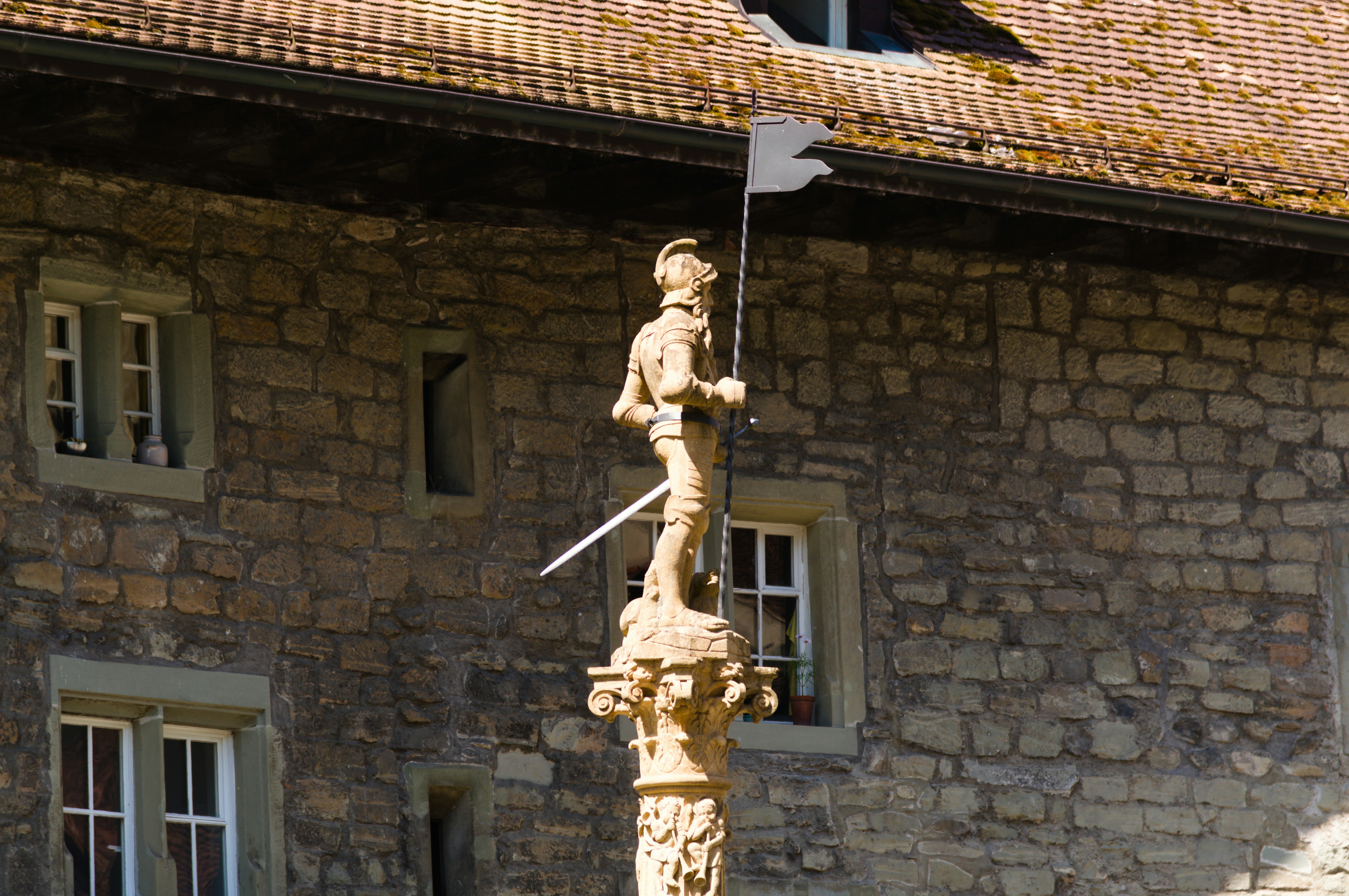 Stone Guardian: A Soldier Statue Surmounting a Carved Column