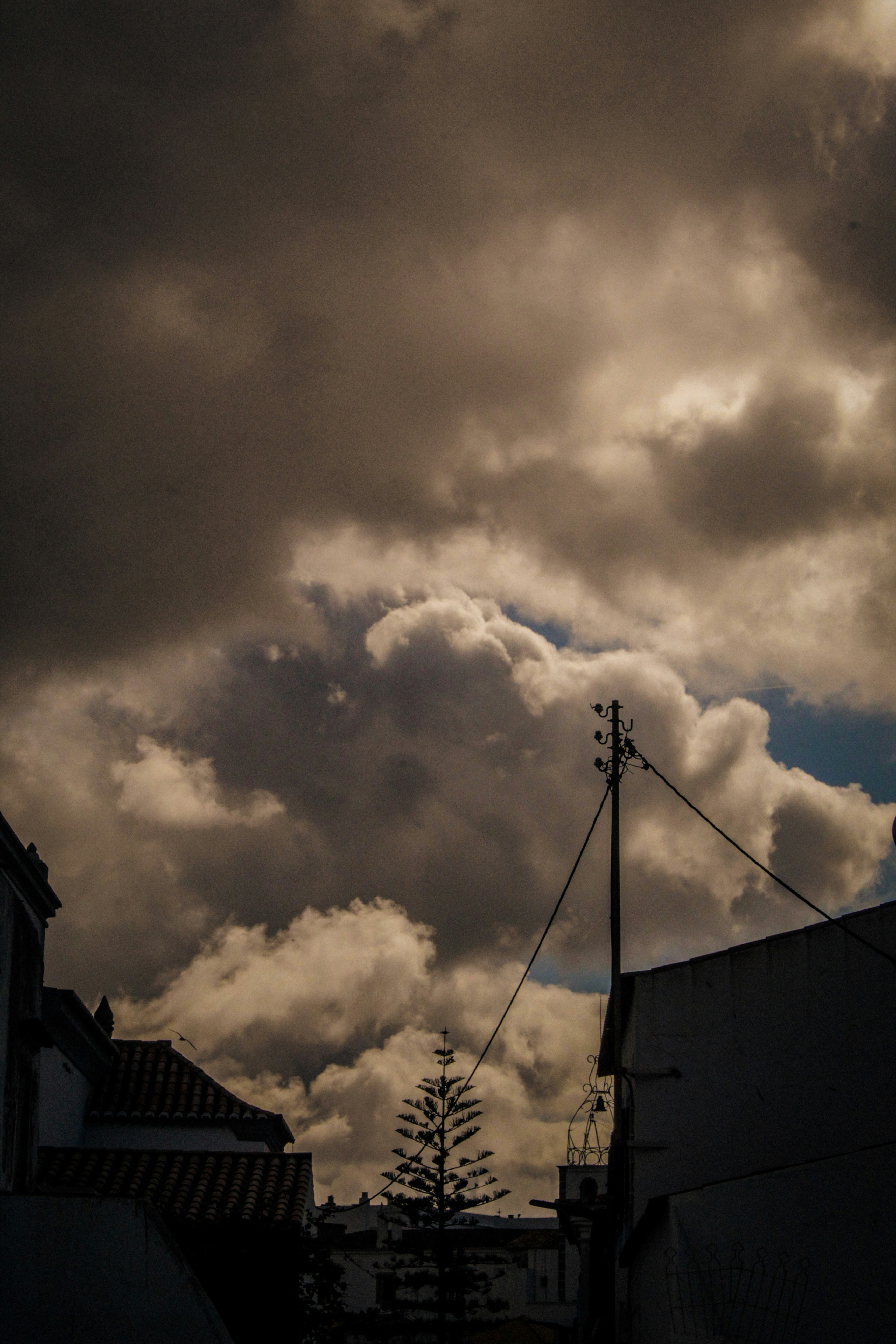 Skyline in Shadow: A Coppery Sunset Over Quiet Rooftops