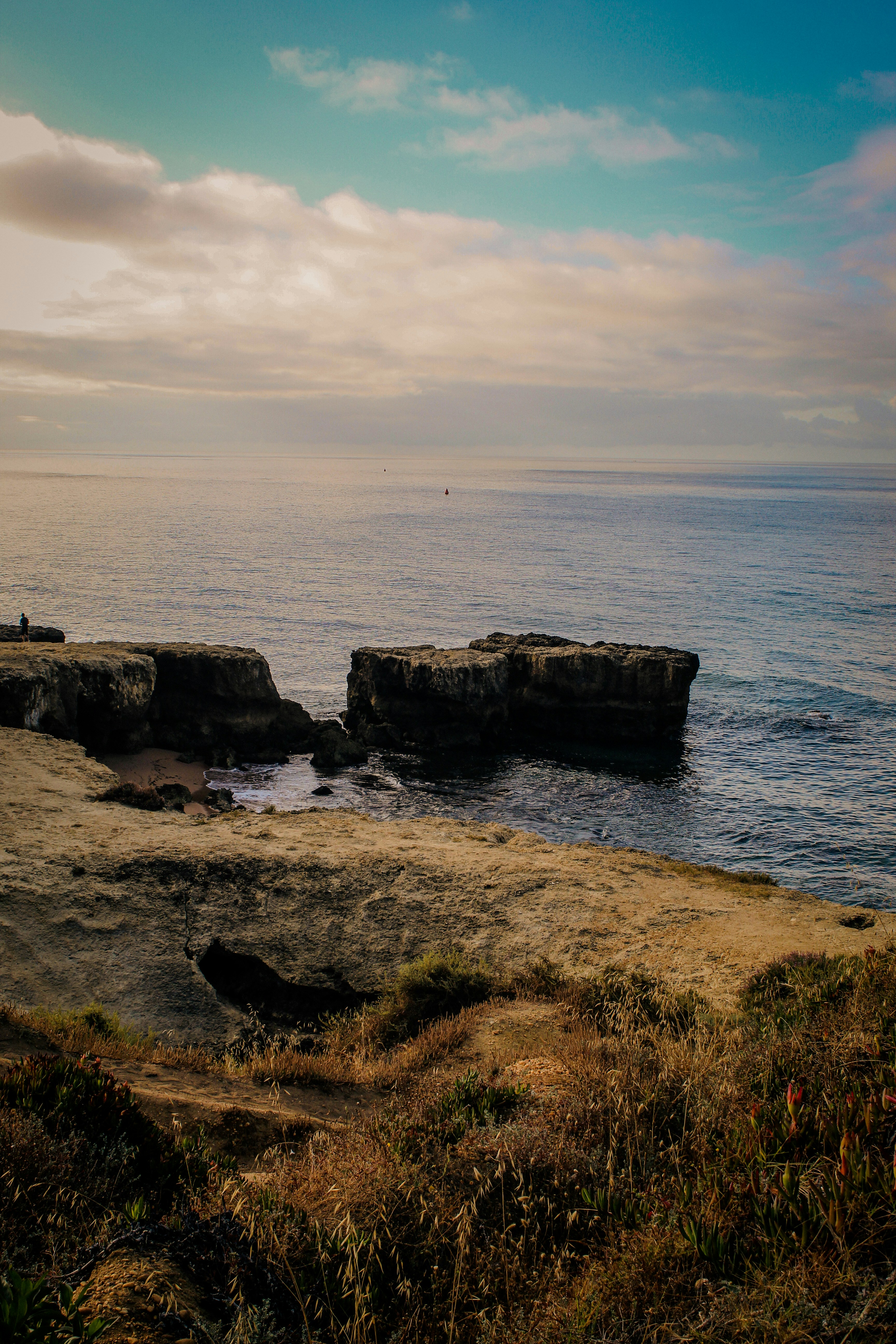 Coastal Terrace at Dusk: Weathered Rocks Meet Quiet Sea