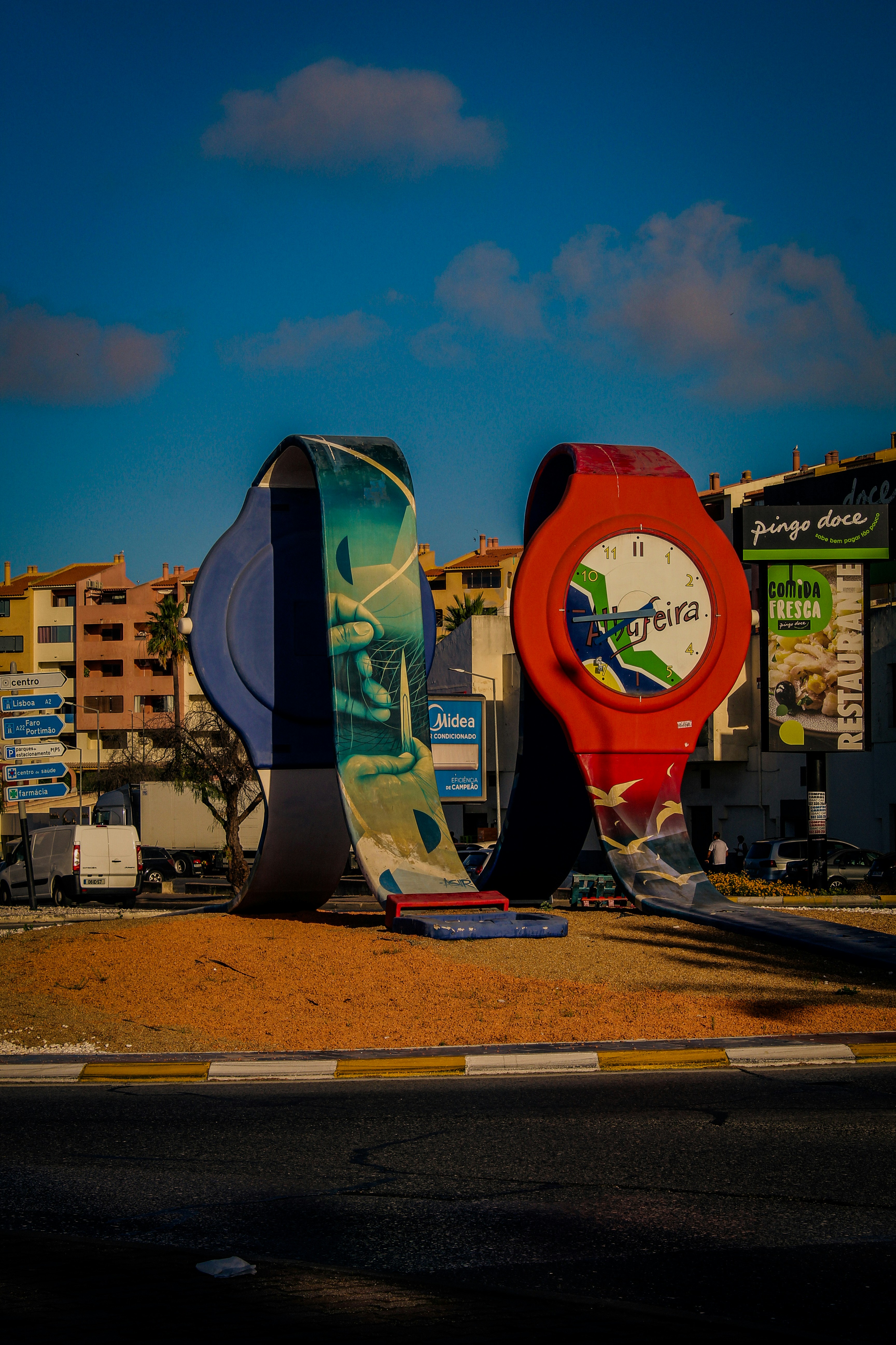 Kinetic Clock Hands in the Roundabout: A Colorful Urban Sculpture