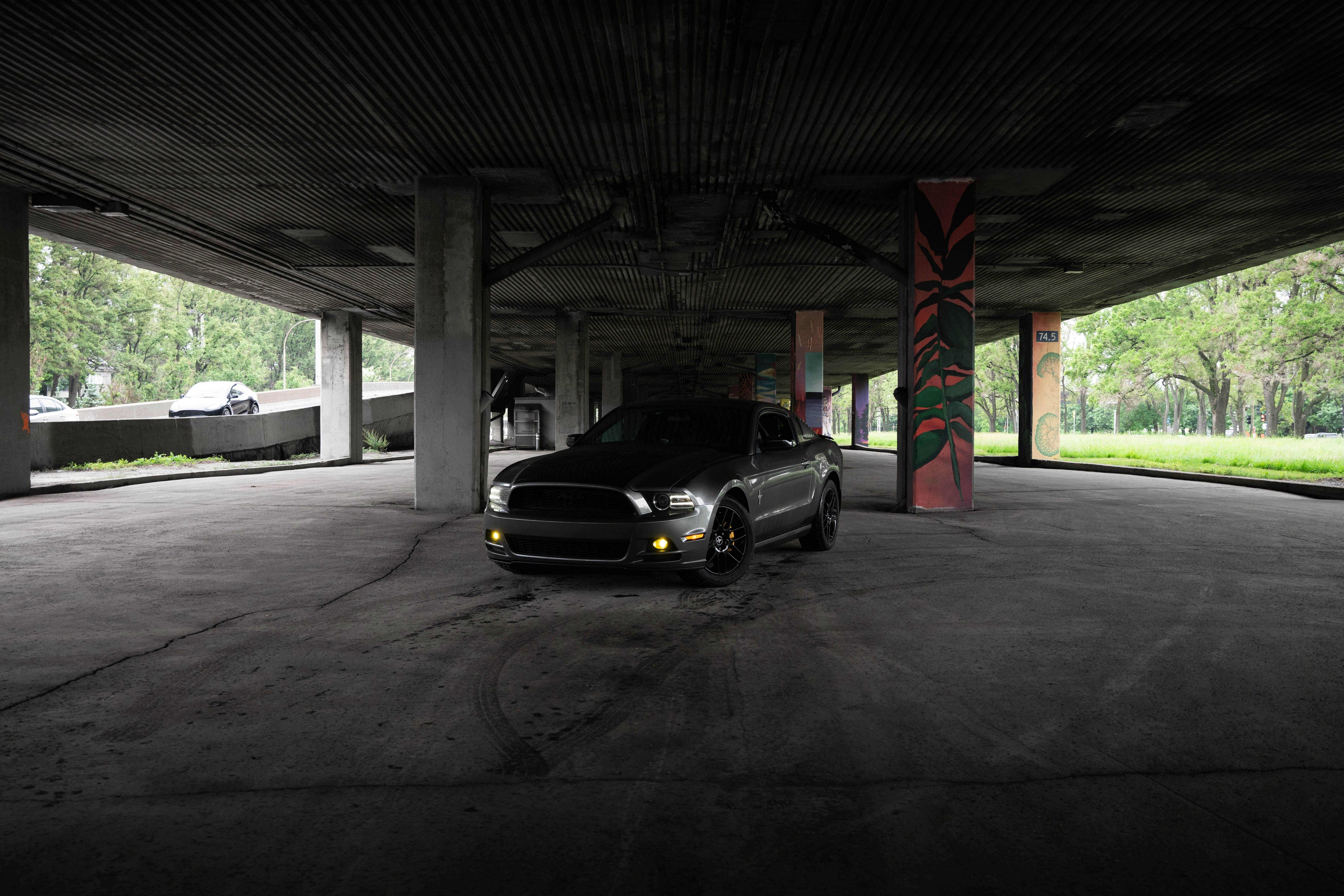 Dark Ford under Concrete Canopy: The Car in the Hidden Parking Arches