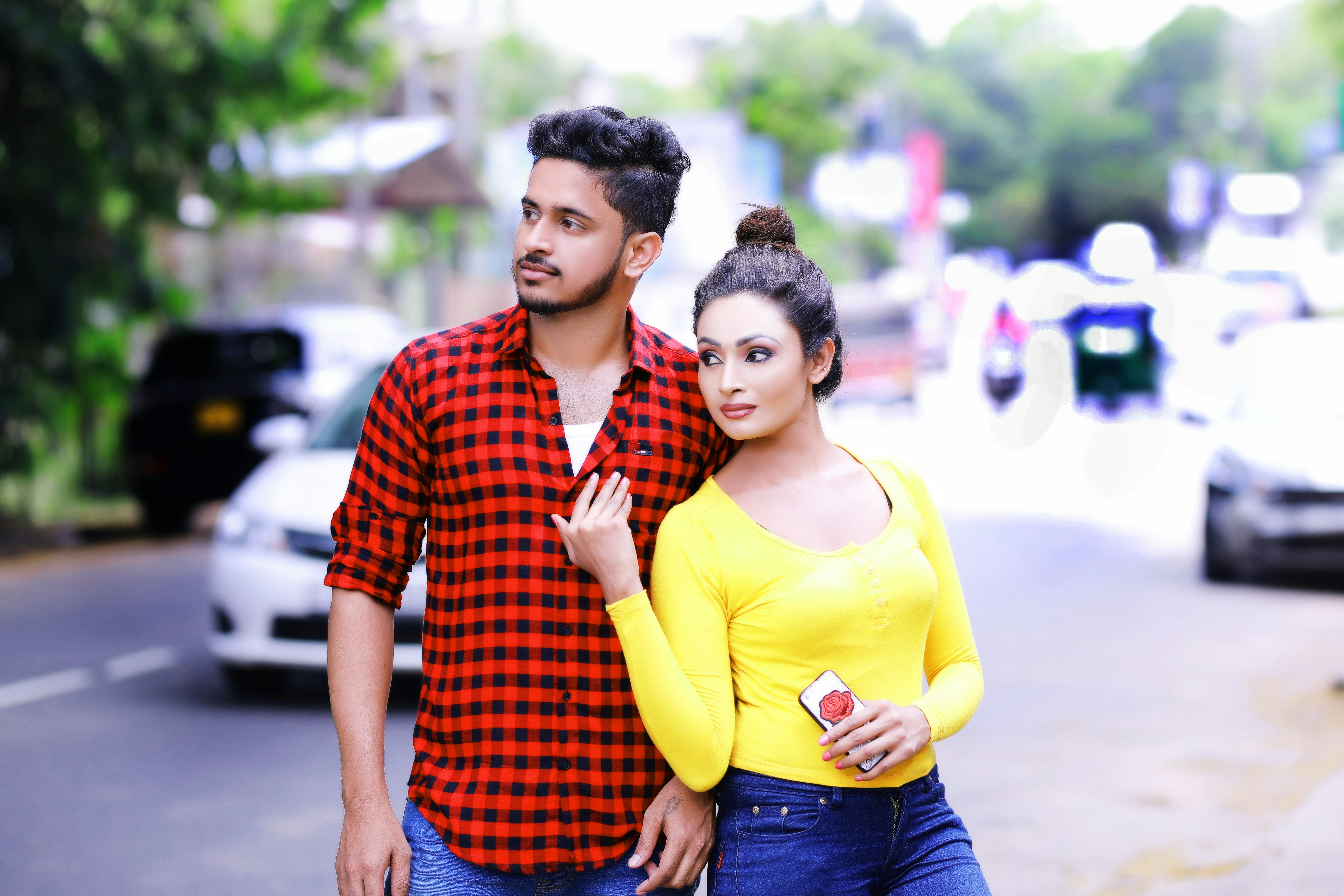 Two in motion: a candid stroll through a sunlit city street