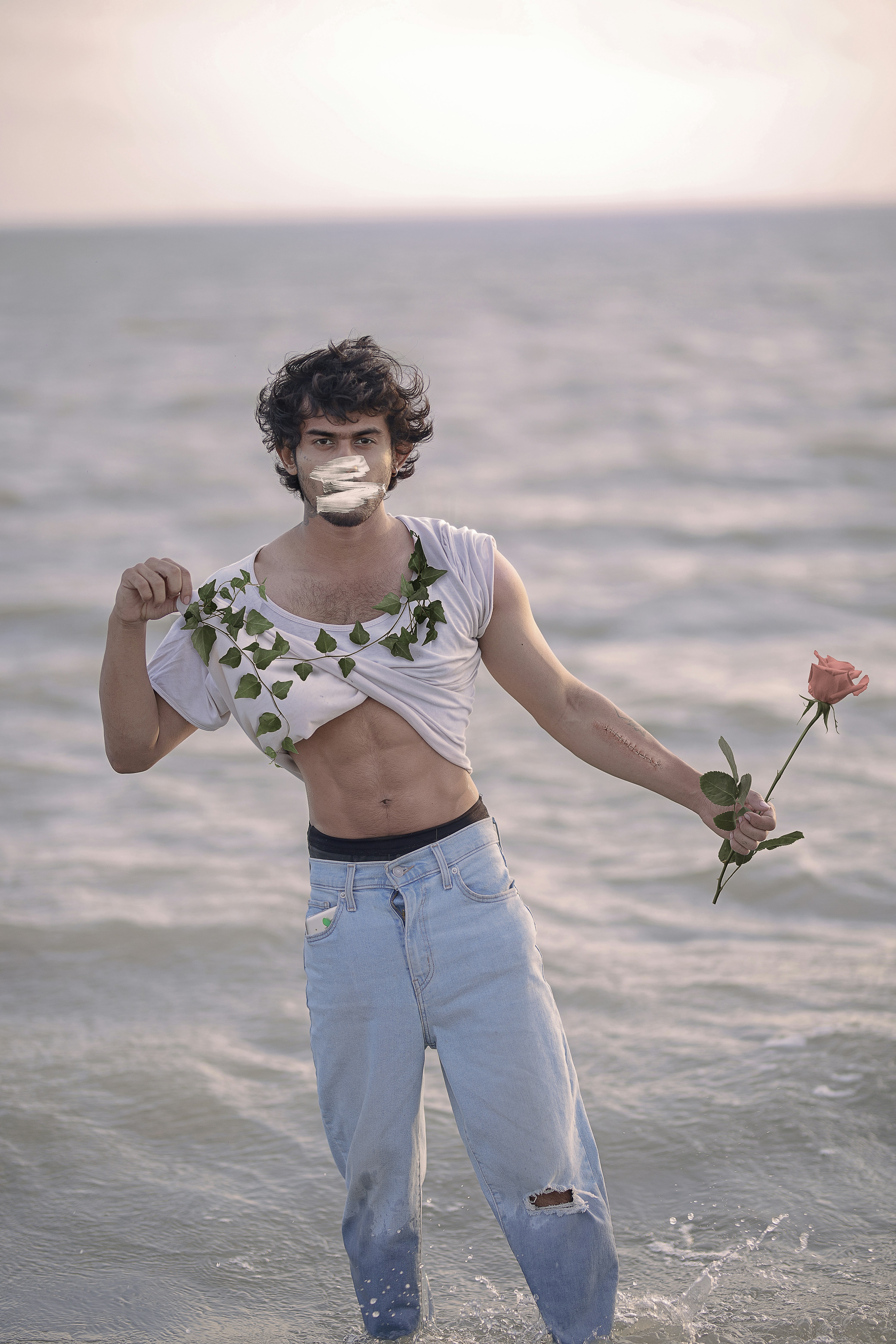 Rose on the Shore: A Playful Pose with a Flower and Ivy