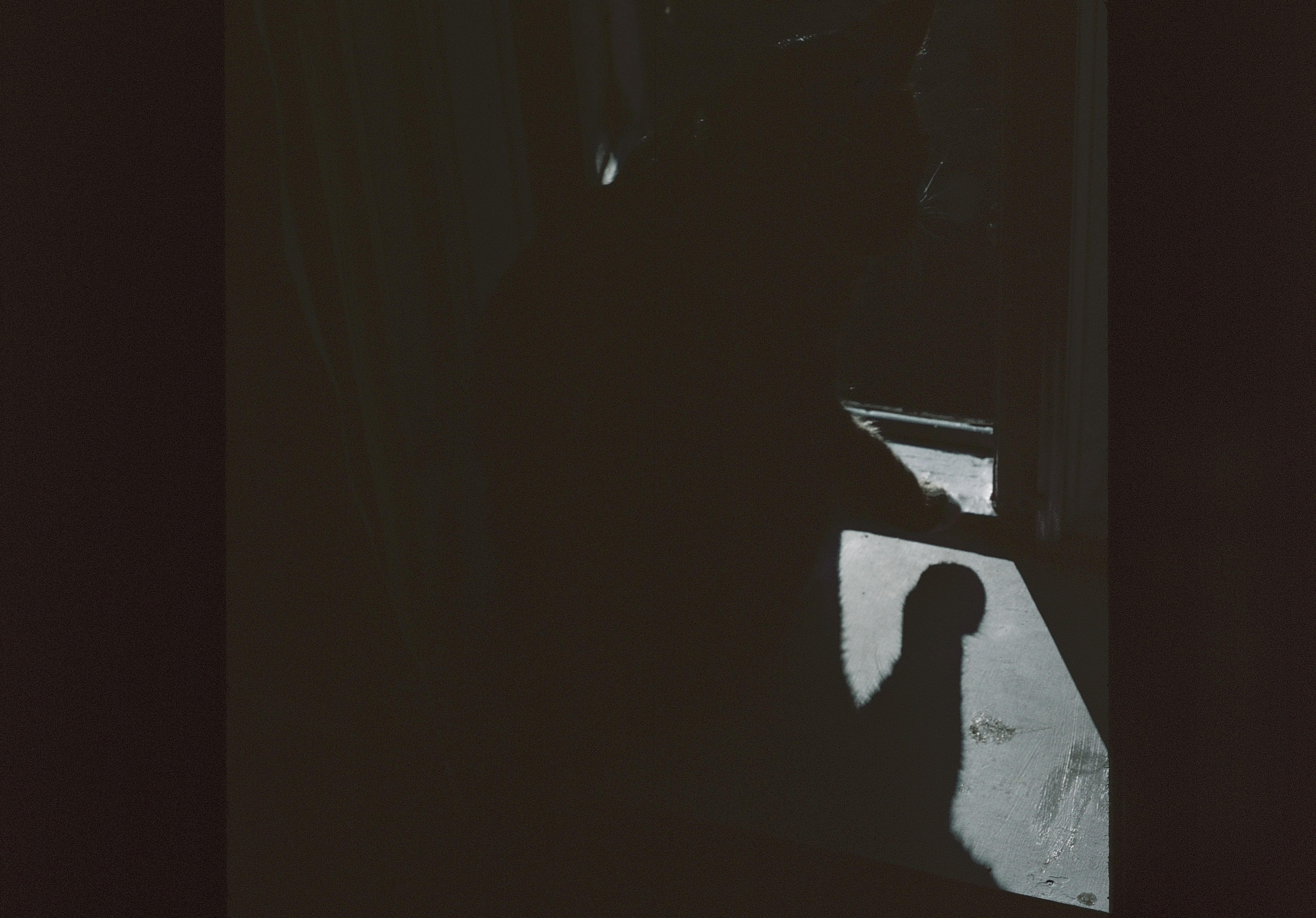 Shadowed doorway: a lone silhouette etched in half-light