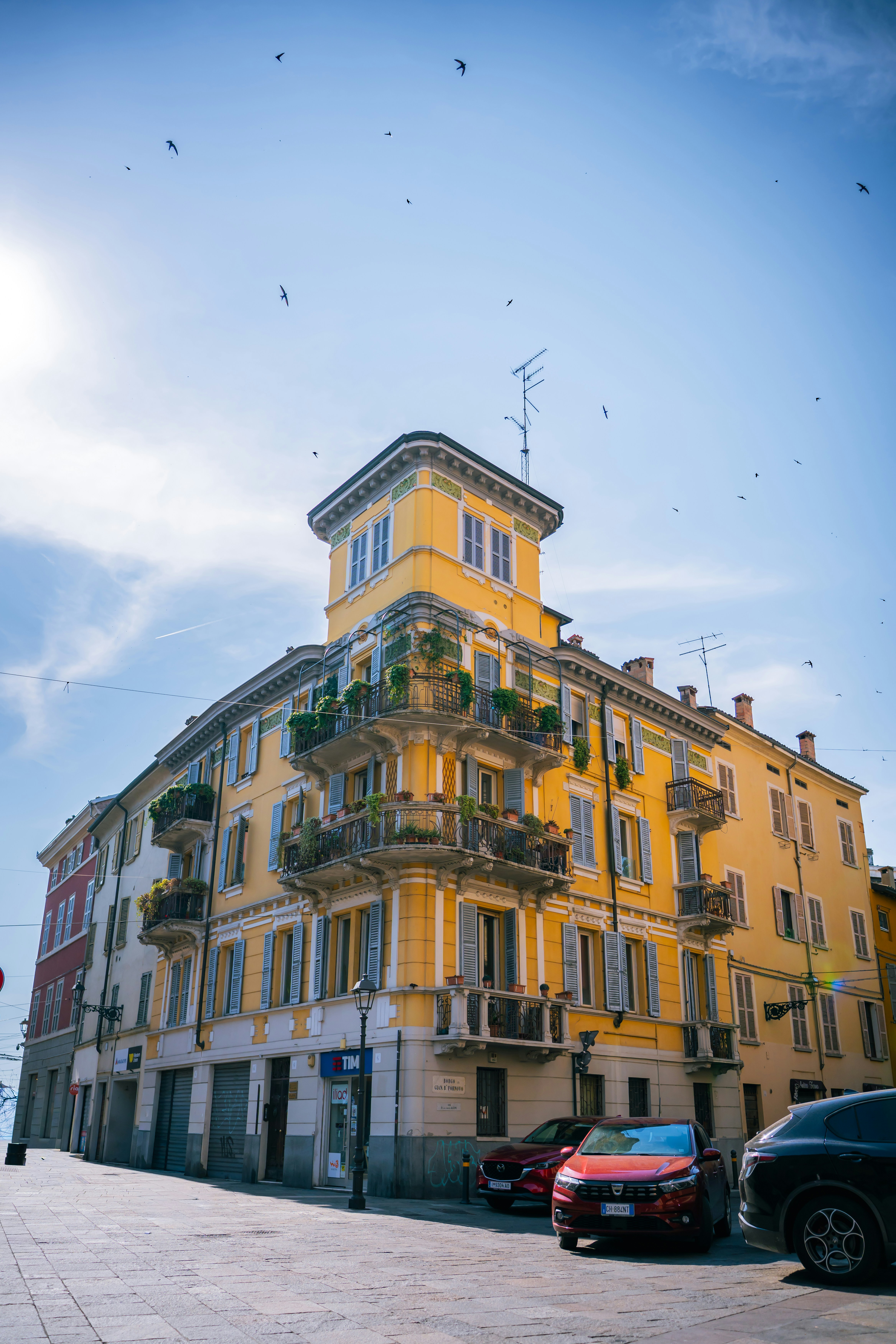 Sunlit Yellow Terrace: A Corner Building Standing Tall in the Piazza