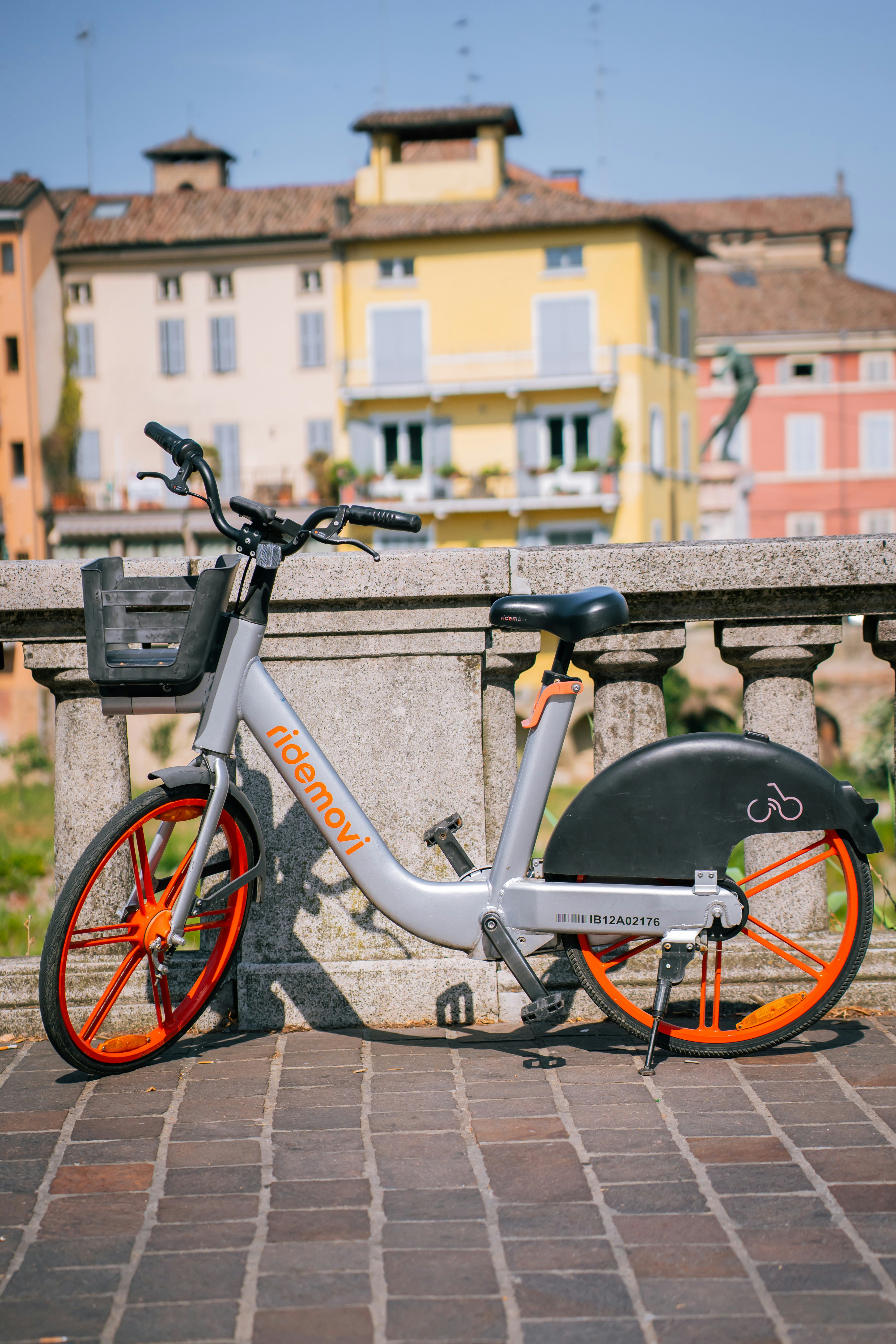 Orange-spoked E-bike Guarded by Italian Facades