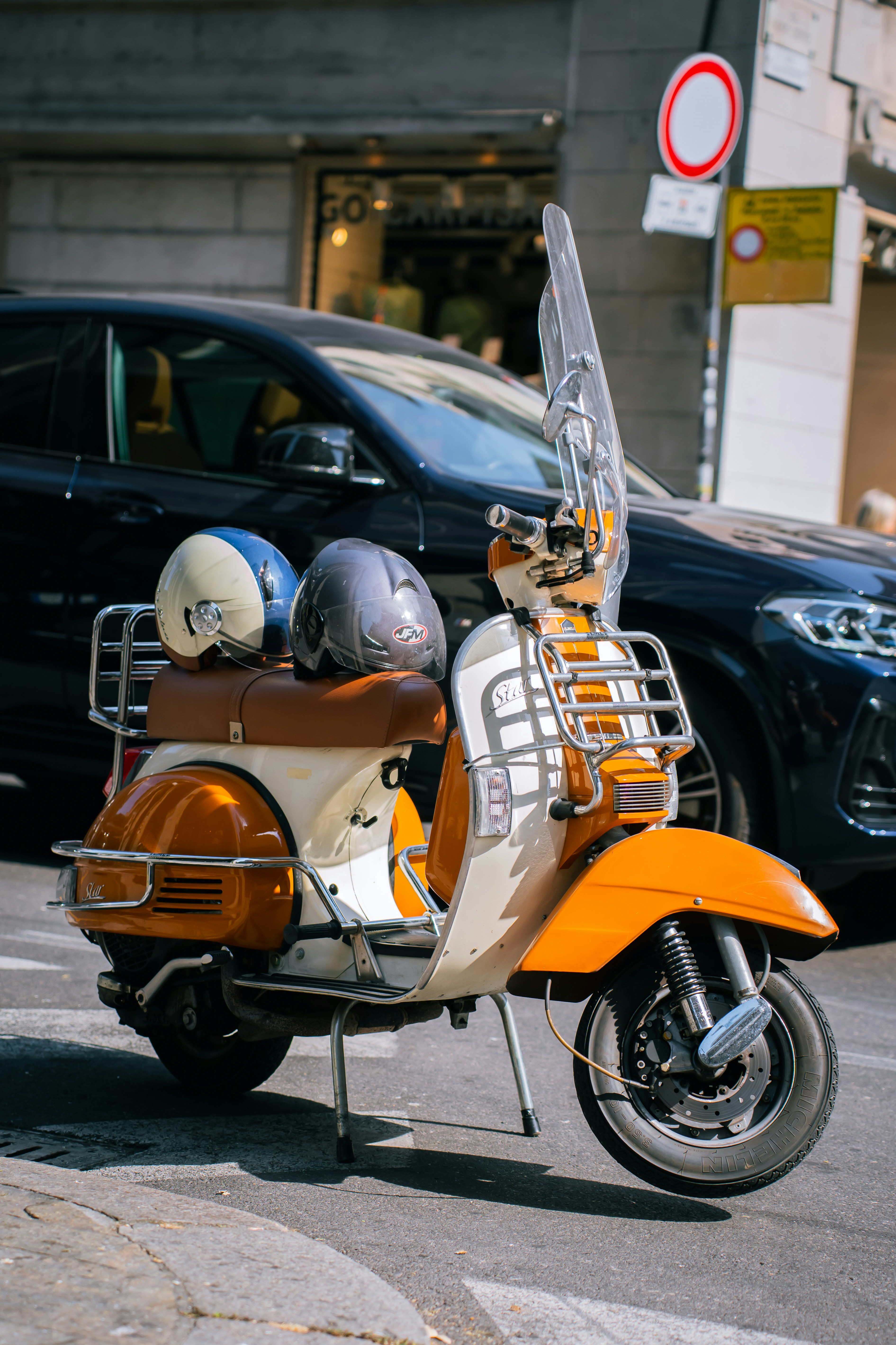 Orange Vespa at the City Edge: A Snapshot of Urban Calm