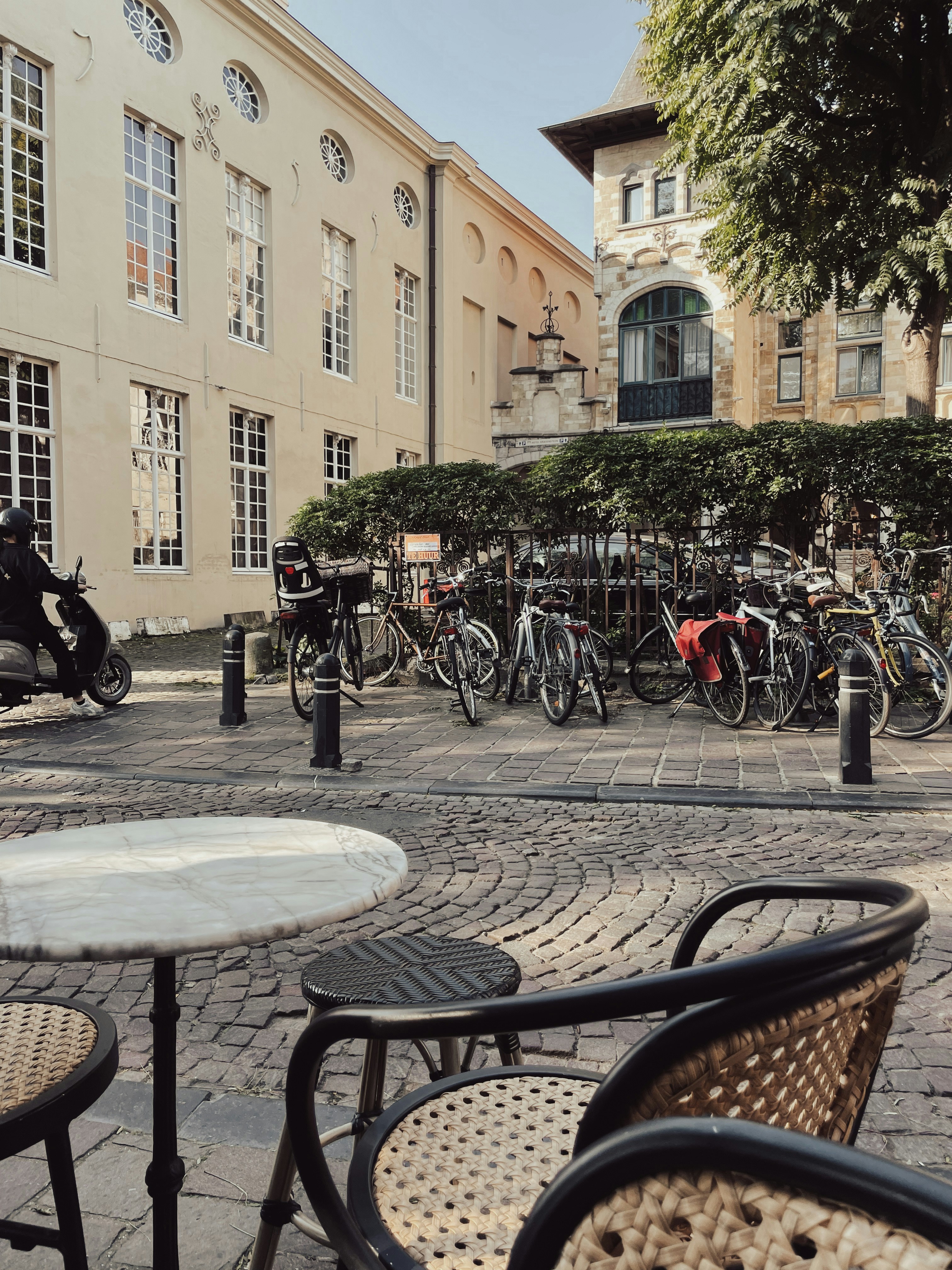Bicycle Courtyard Echo: Sunlit Café Corner by the Historic Facade