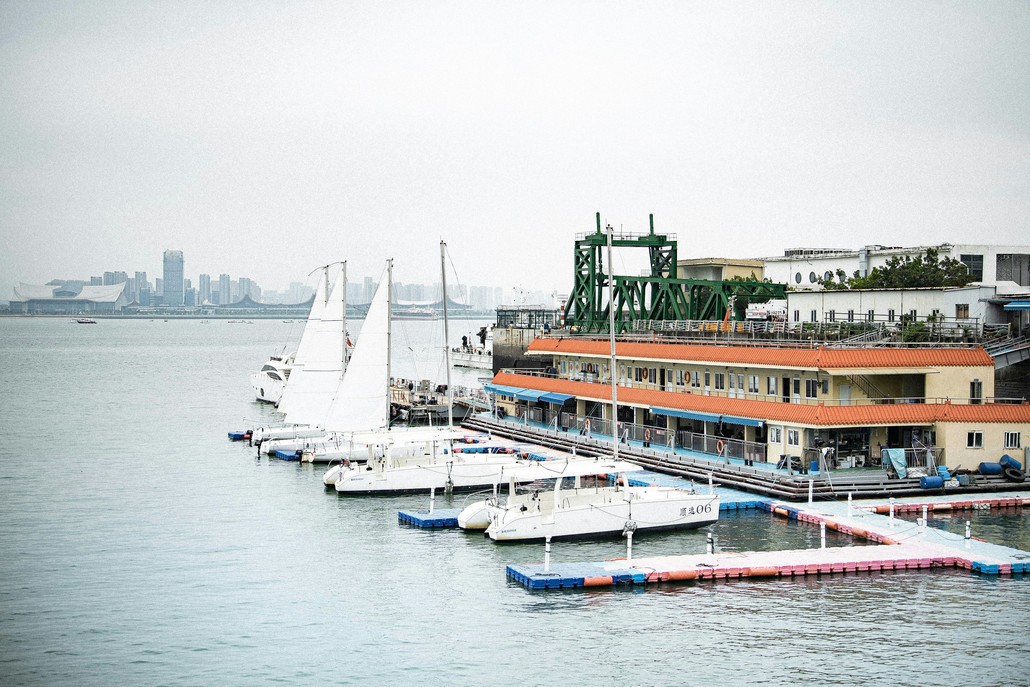 Sailboats by a Modern Waterfront Port