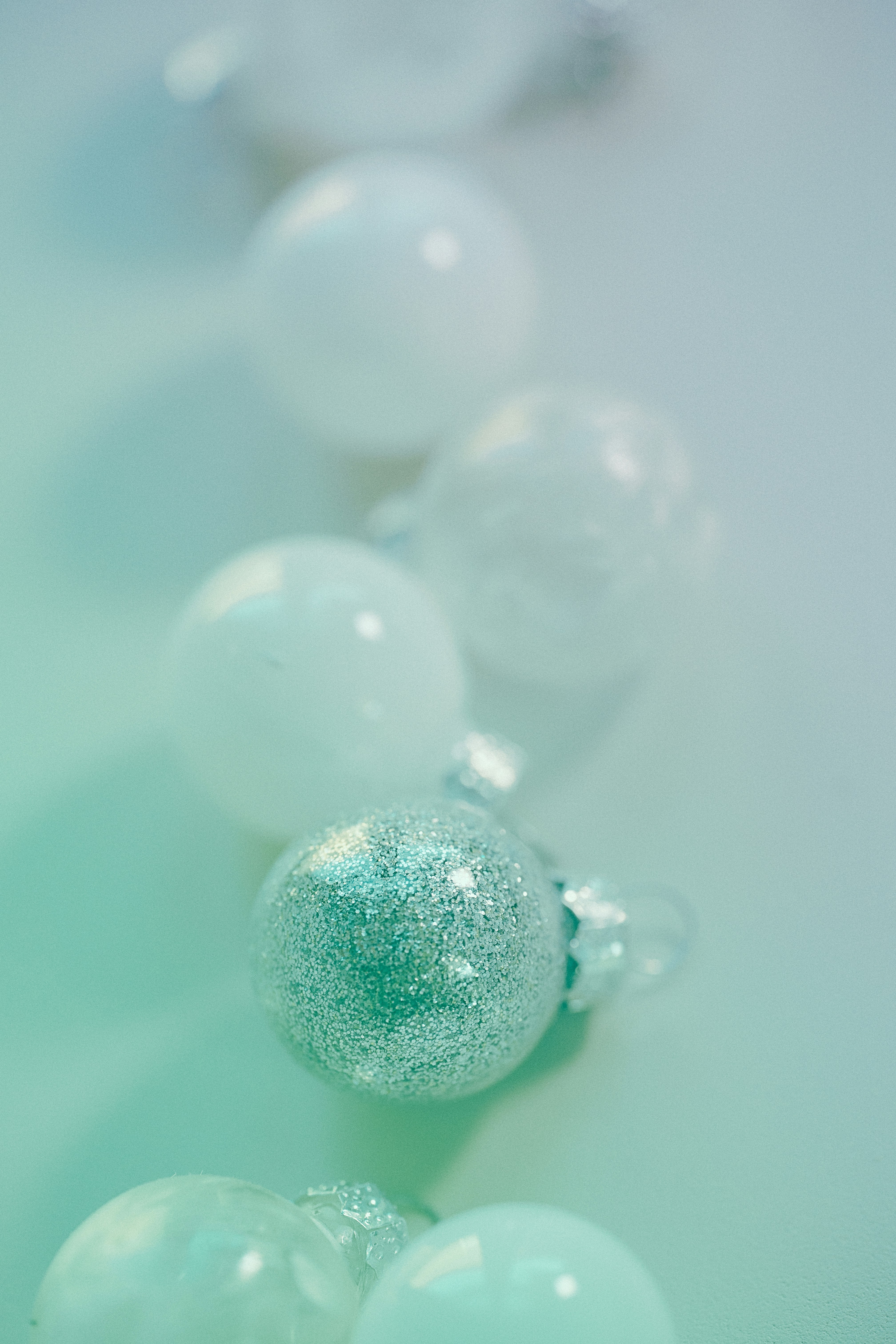 Pearl Ribbon: A Close-Up of Frosted Spheres in Soft Turquoise Light