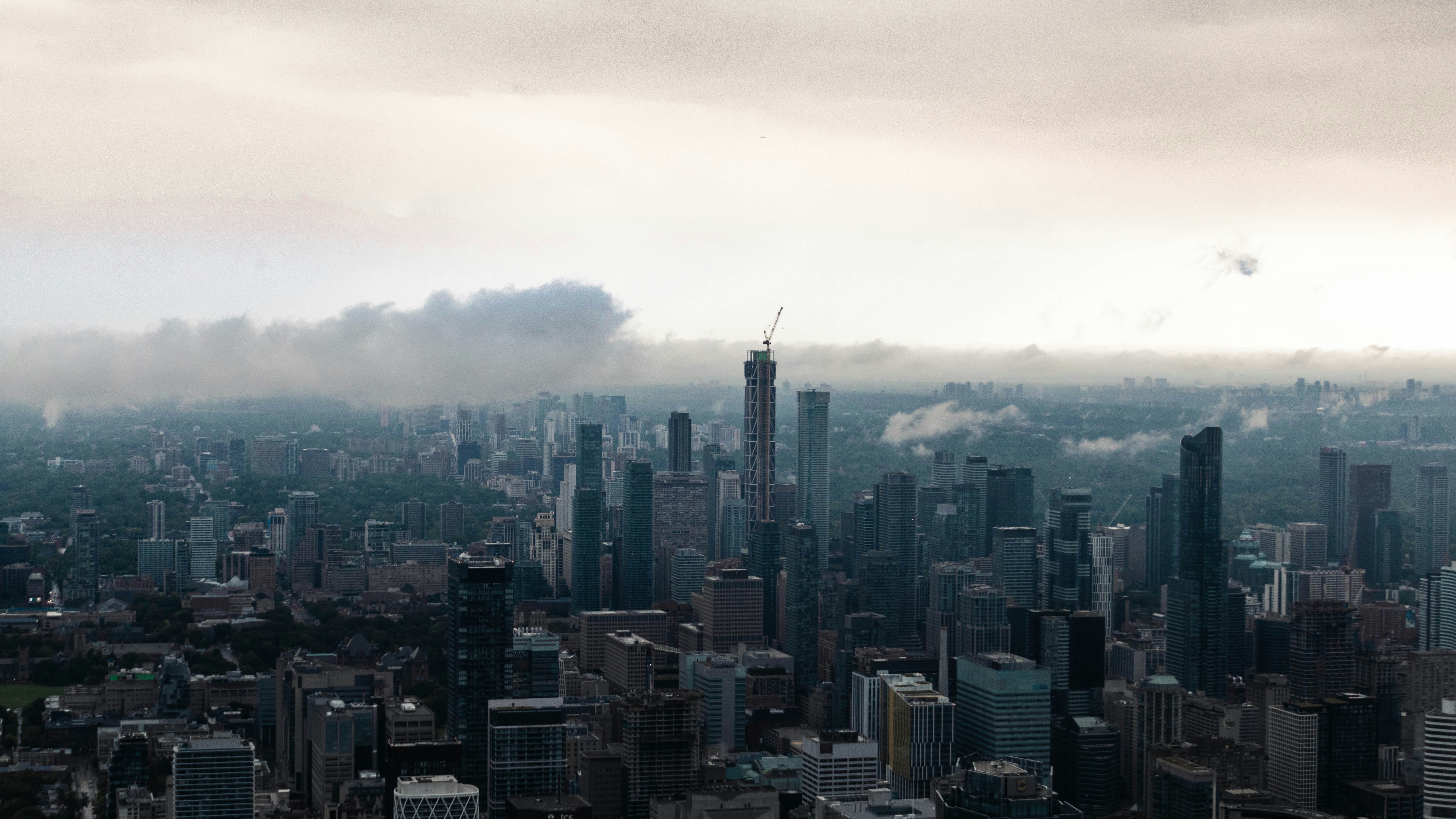 Midday Horizon: A Dense City Grid Under Compressing Clouds