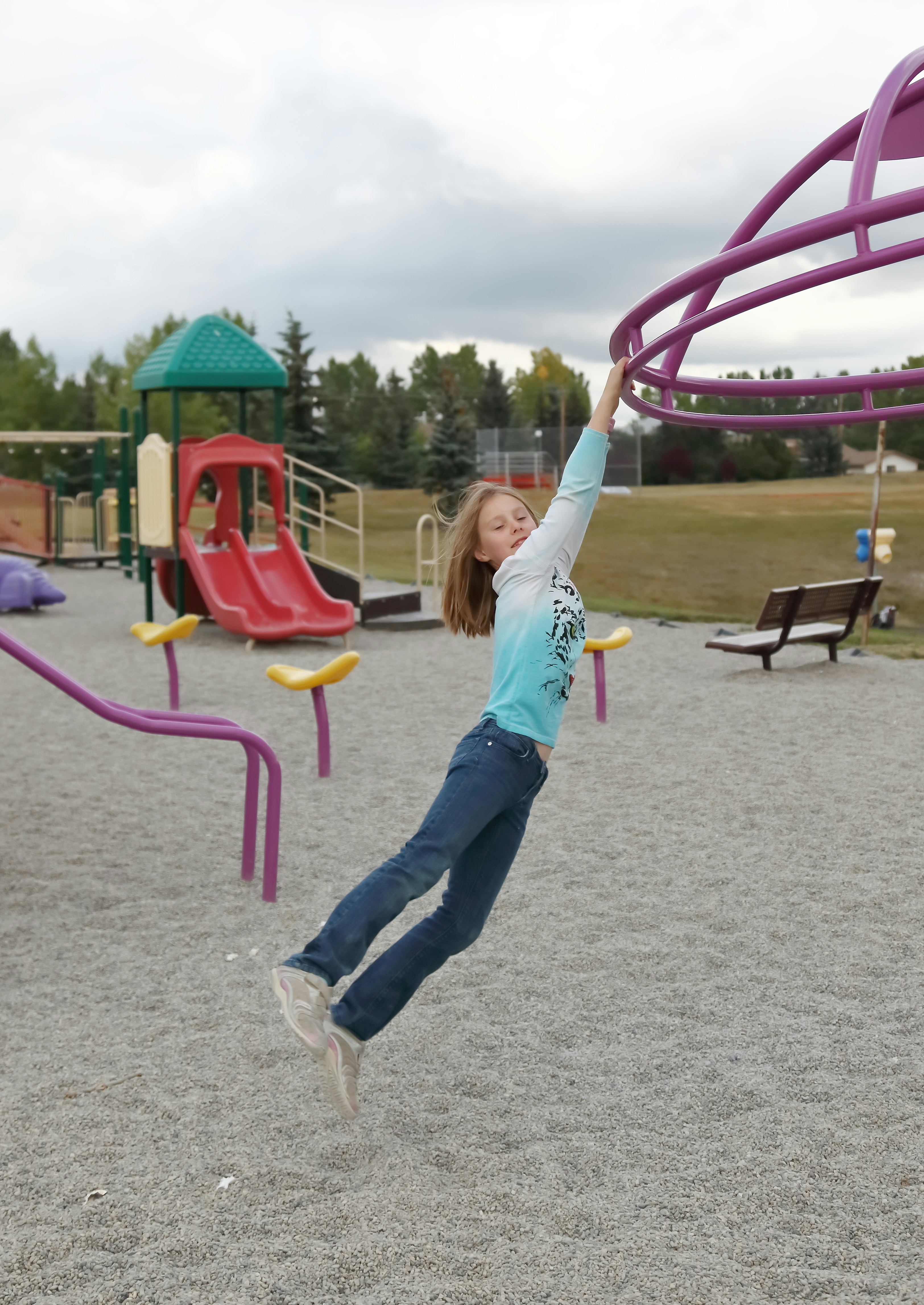 Child Whirl: A Fleeting Moment on the Playground Spinning Rings