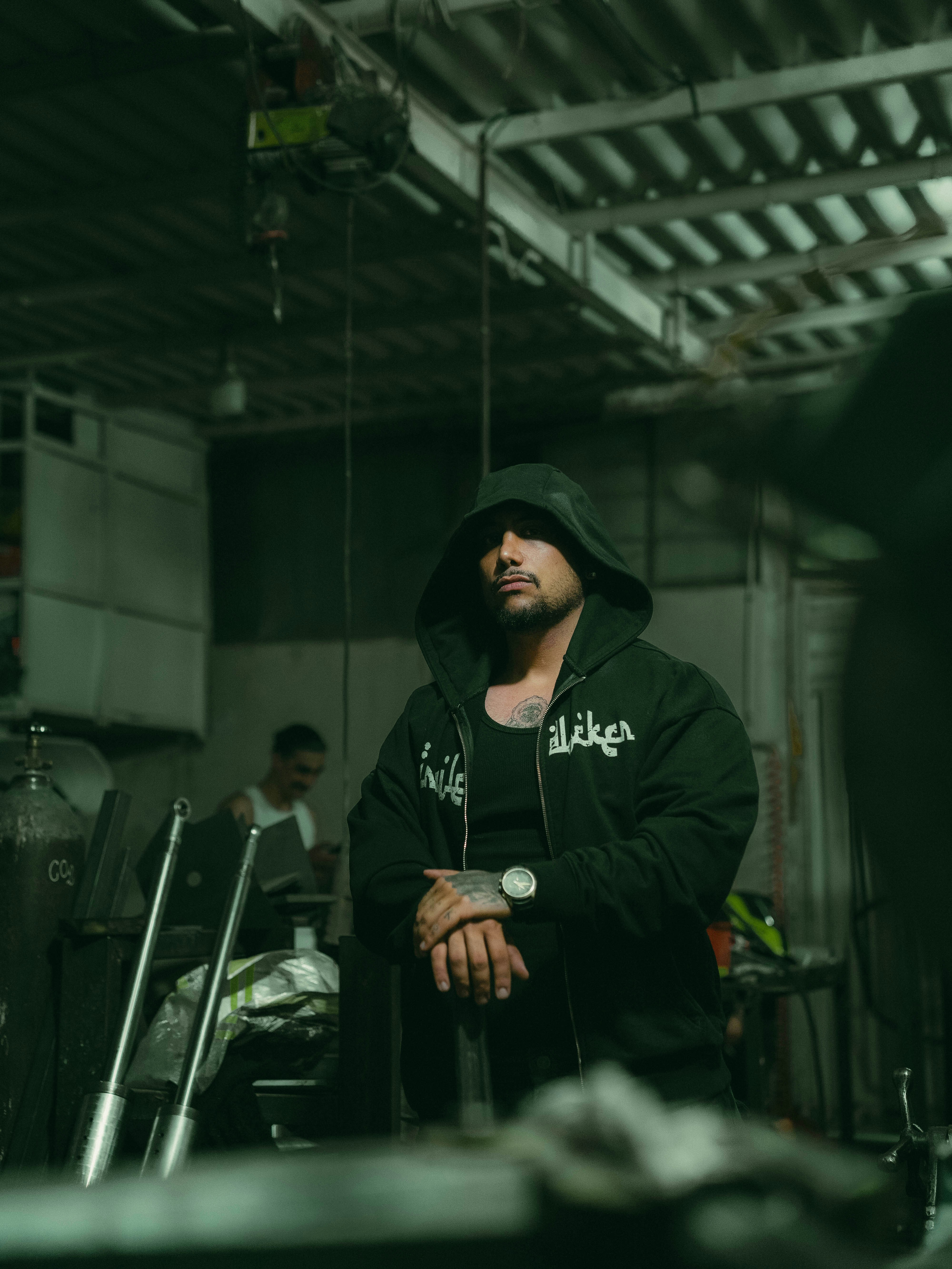Hooded Confidence: A Street Portrait with Subtle Stance
