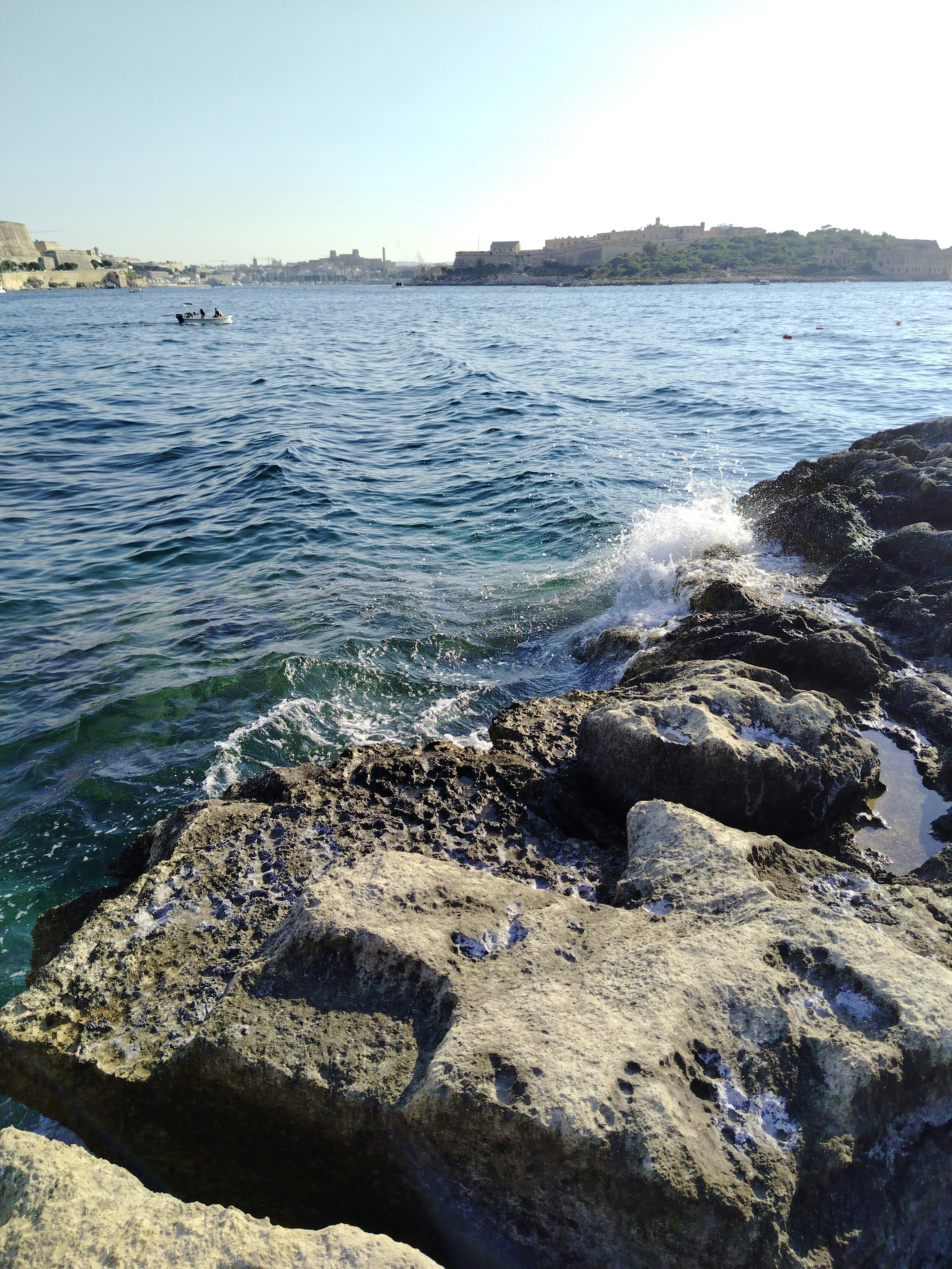 Waves crashing against the rocks.