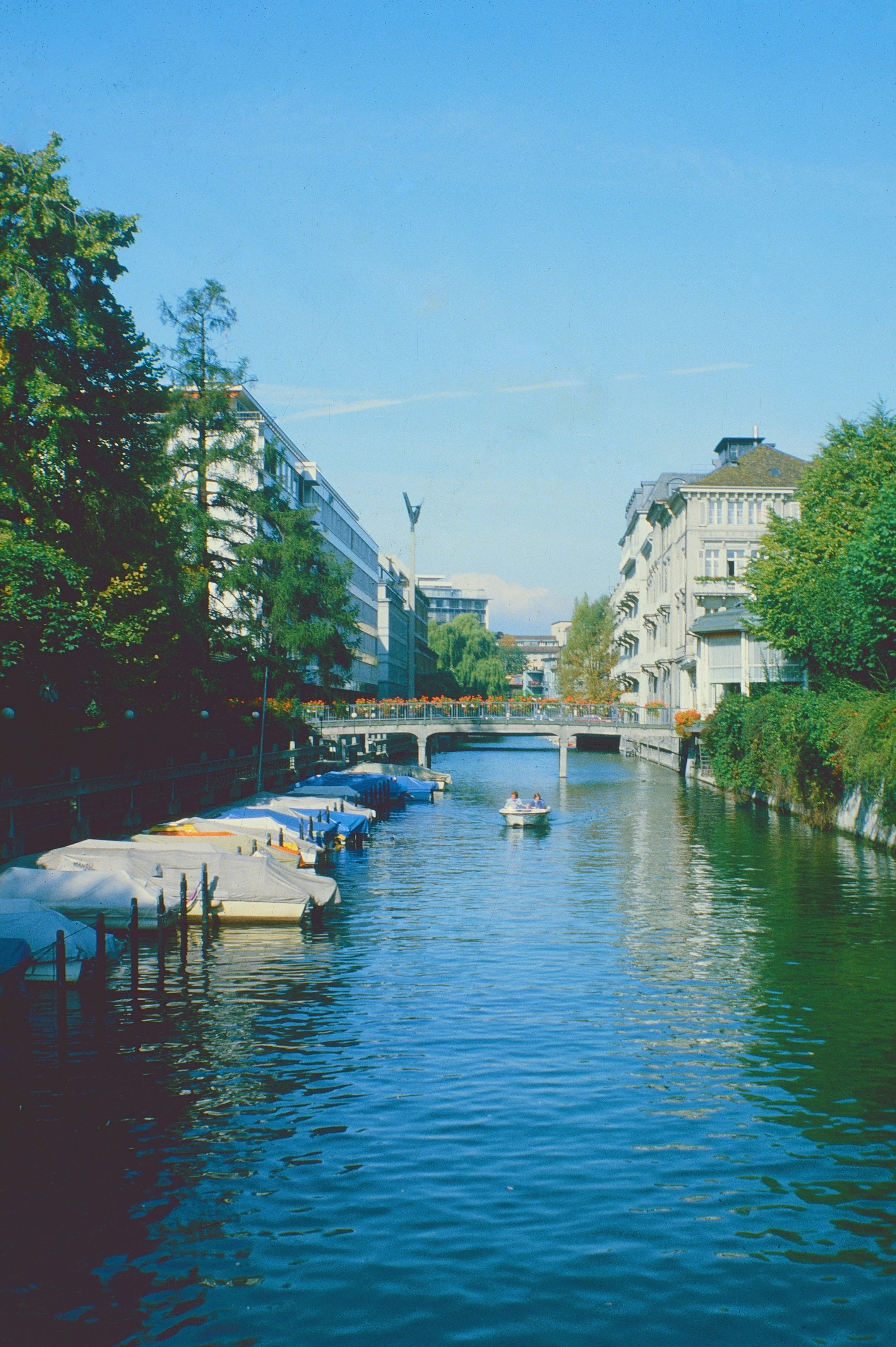City Canal Lunch Break: Boats, Reflections, and Brick Facades