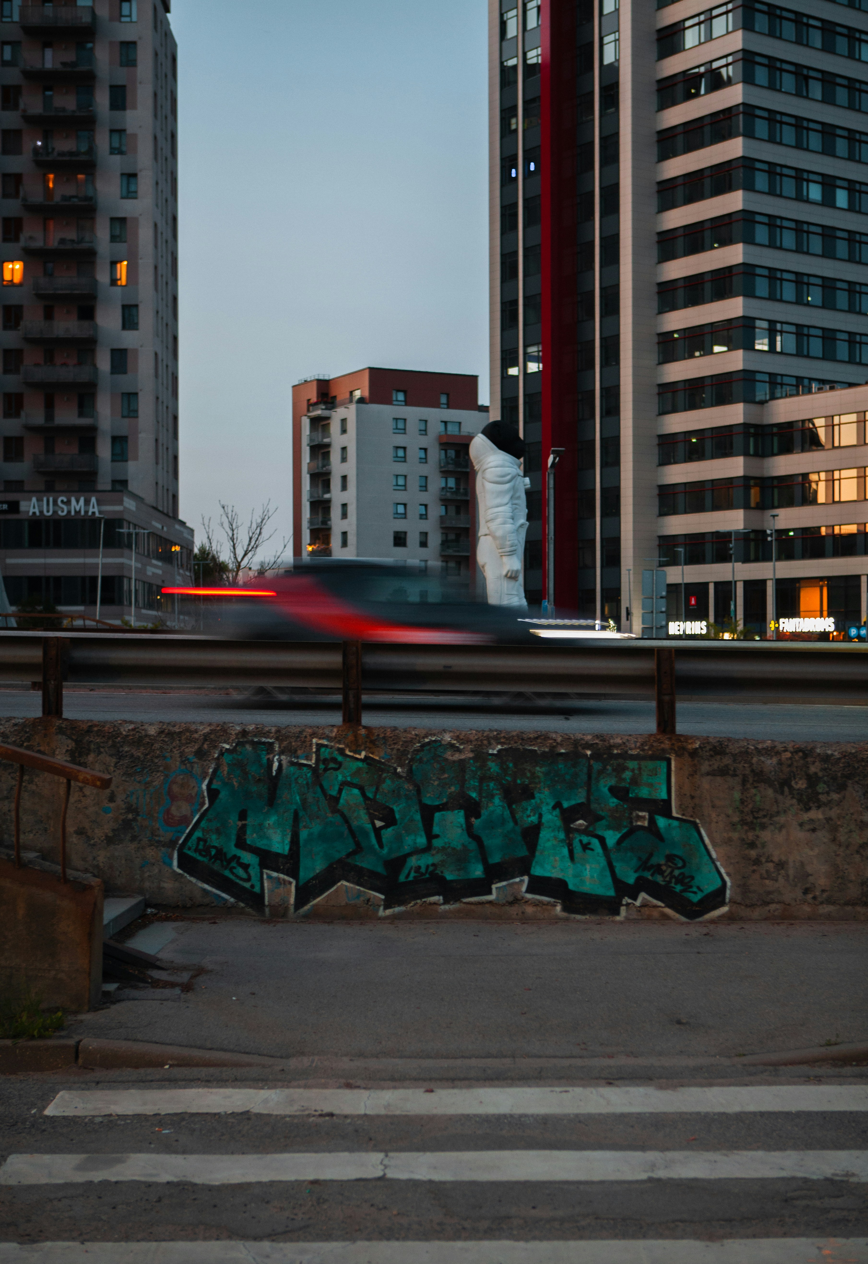 Urban Nightfall: A Passenger Speeds By Beneath a Quiet Skateboarder