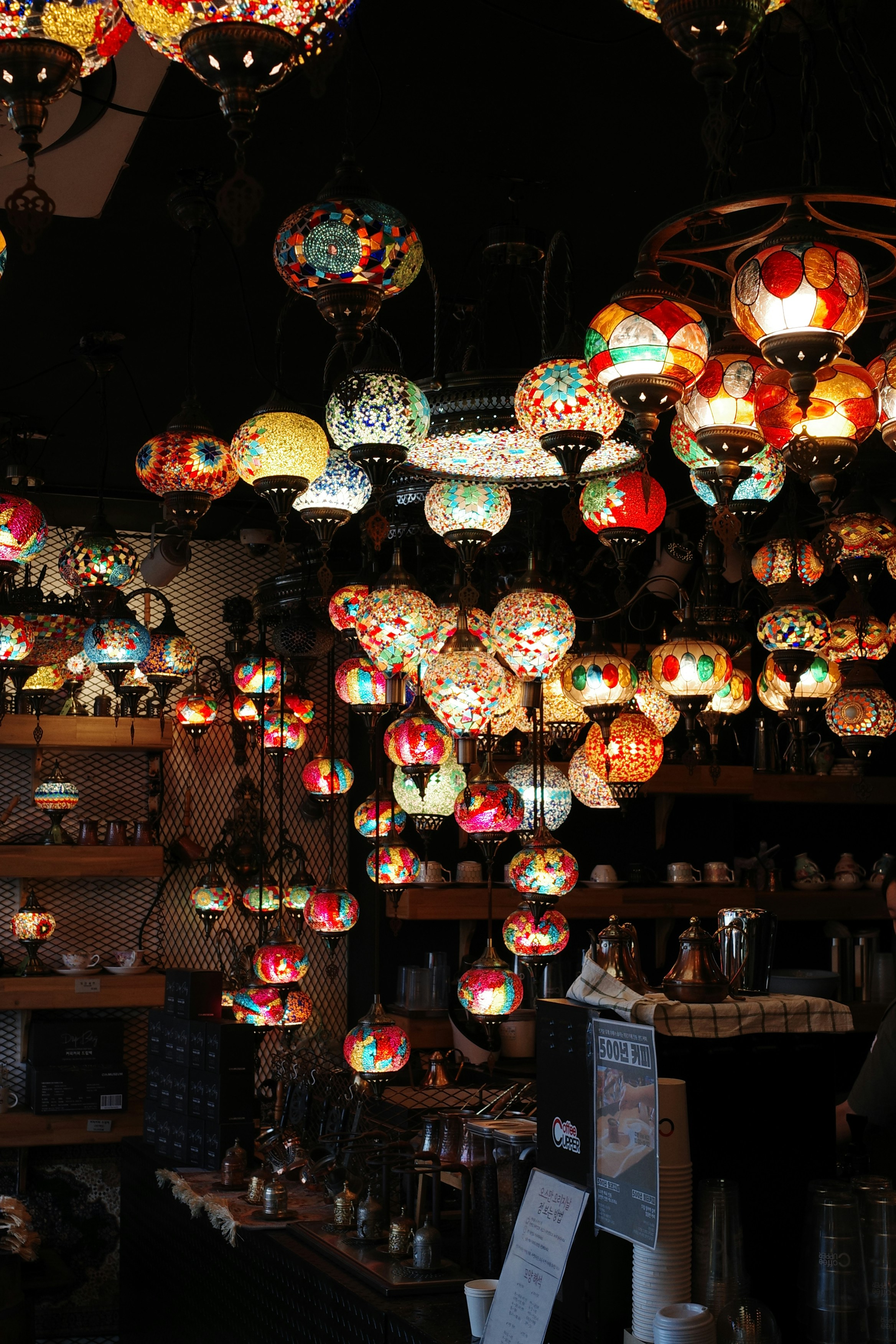 Lantern Mosaic: A Ceiling of Color Over a Dim Café